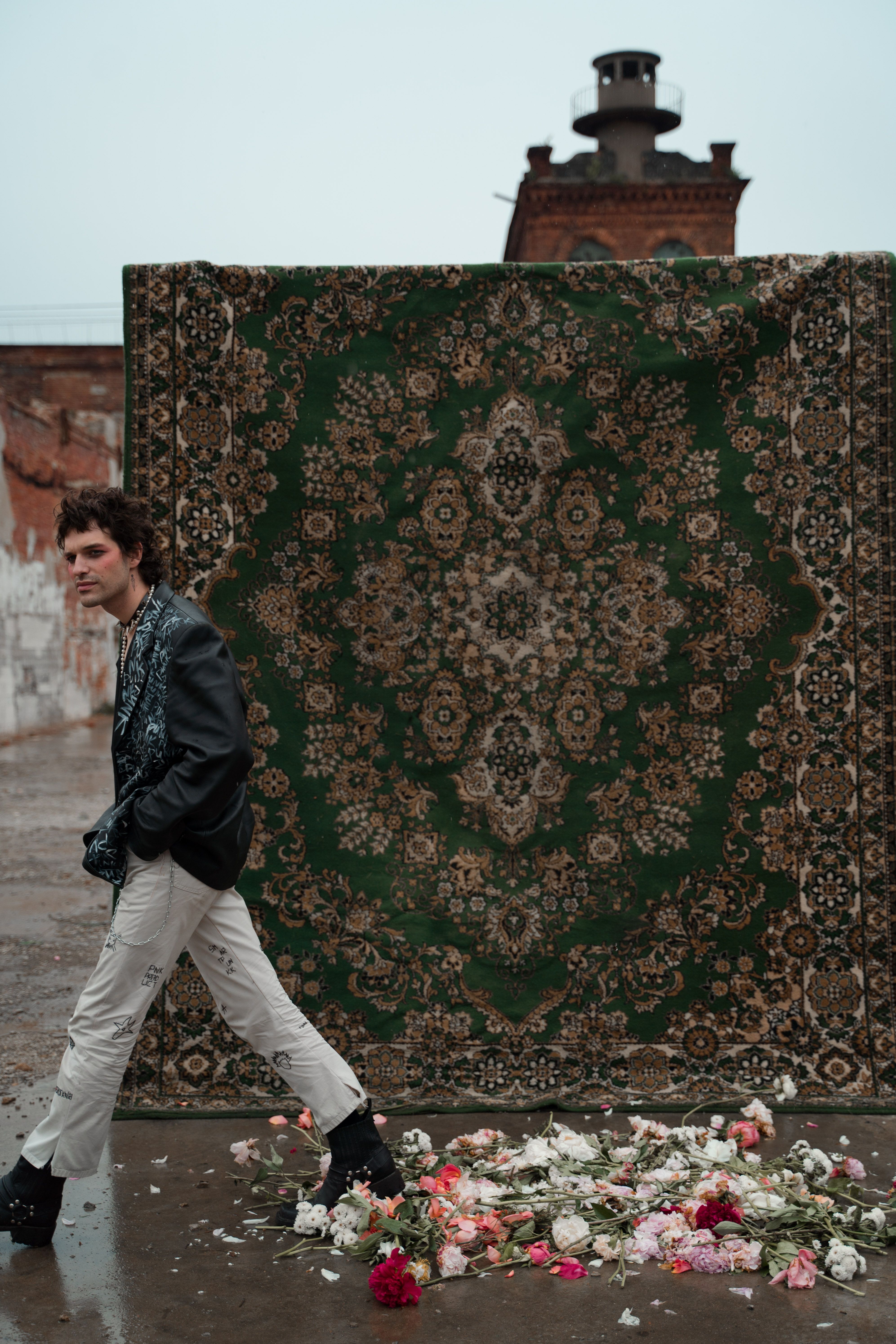 A Man Walking on a Floor with Flowers · Free Stock Photo