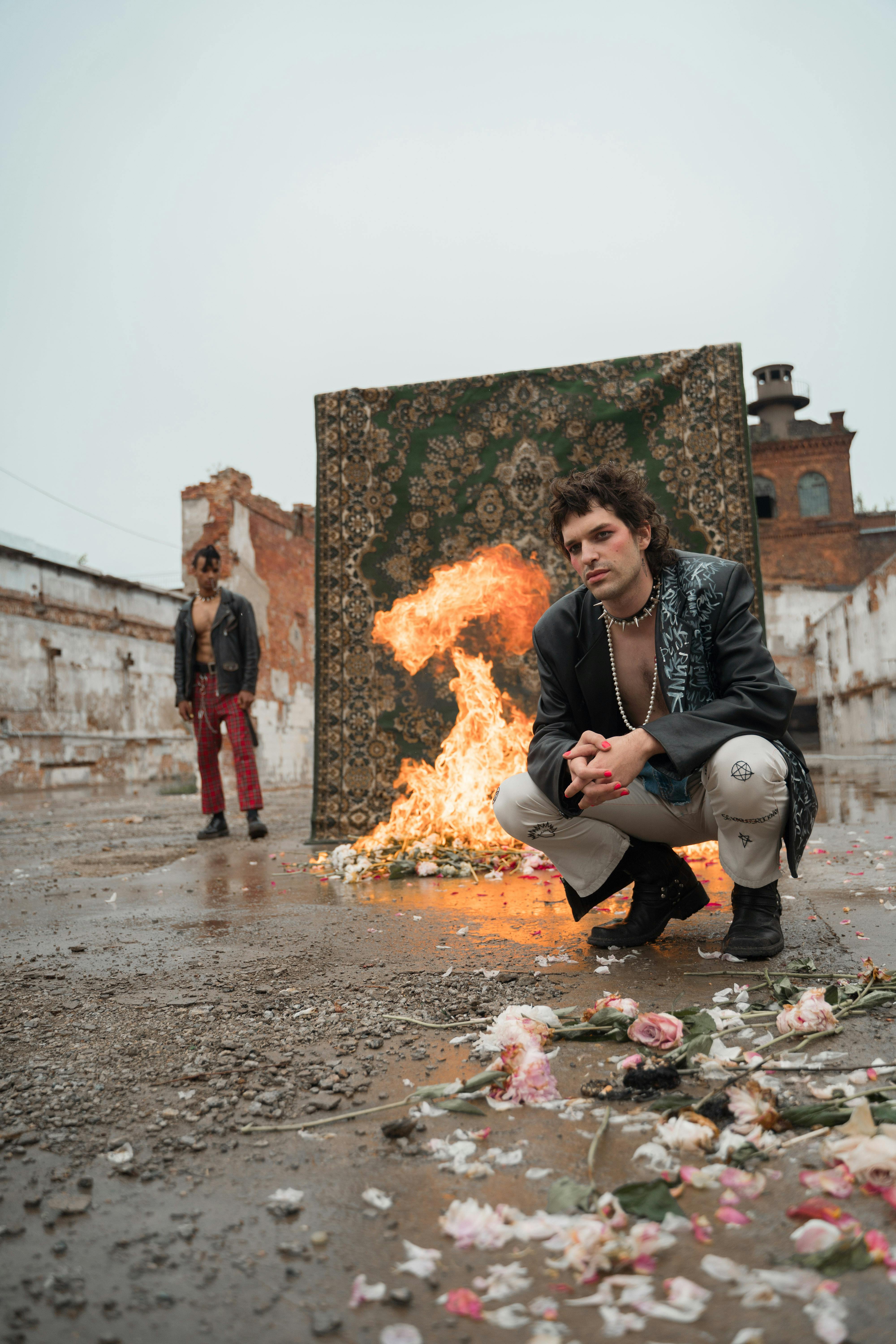 Young Men in Punk Clothes Beside the Burning Flowers · Free Stock Photo