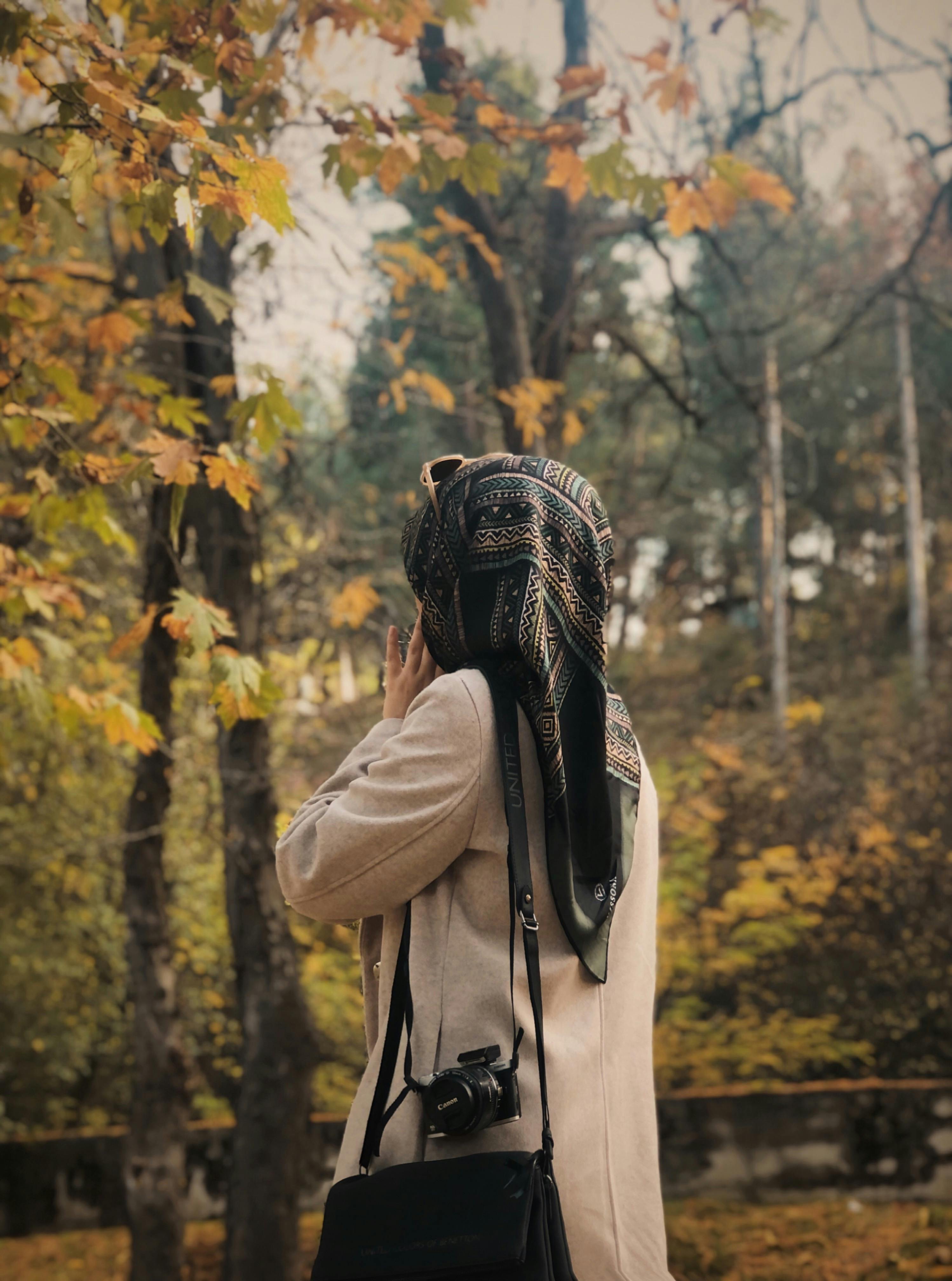 Back View of a Woman Wearing Trench Coat Walking · Free Stock Photo