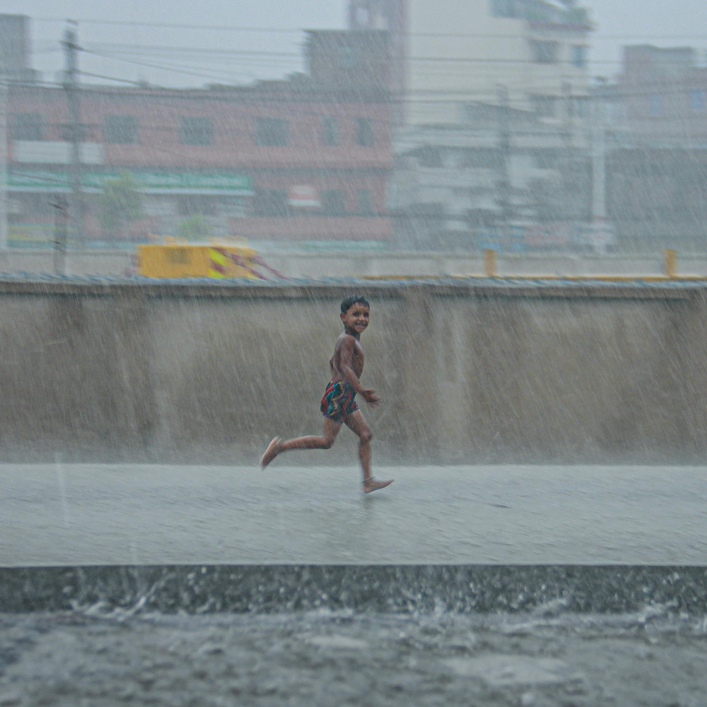 Woman Enjoying The Rain Outside A Grass Field · Free Stock Photo