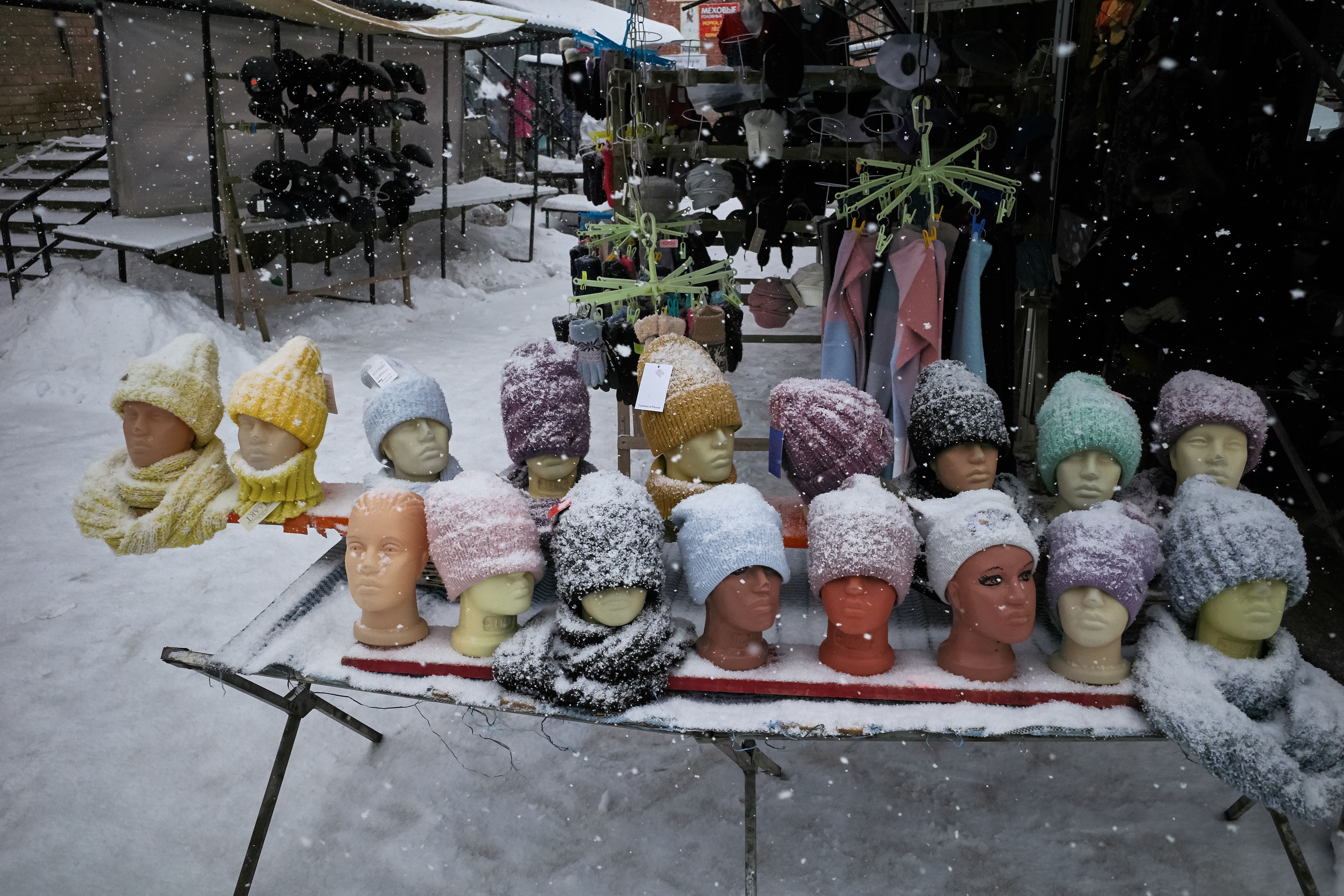 Beanies and Winter Clothing on Display on a Snowy Day · Free Stock Photo