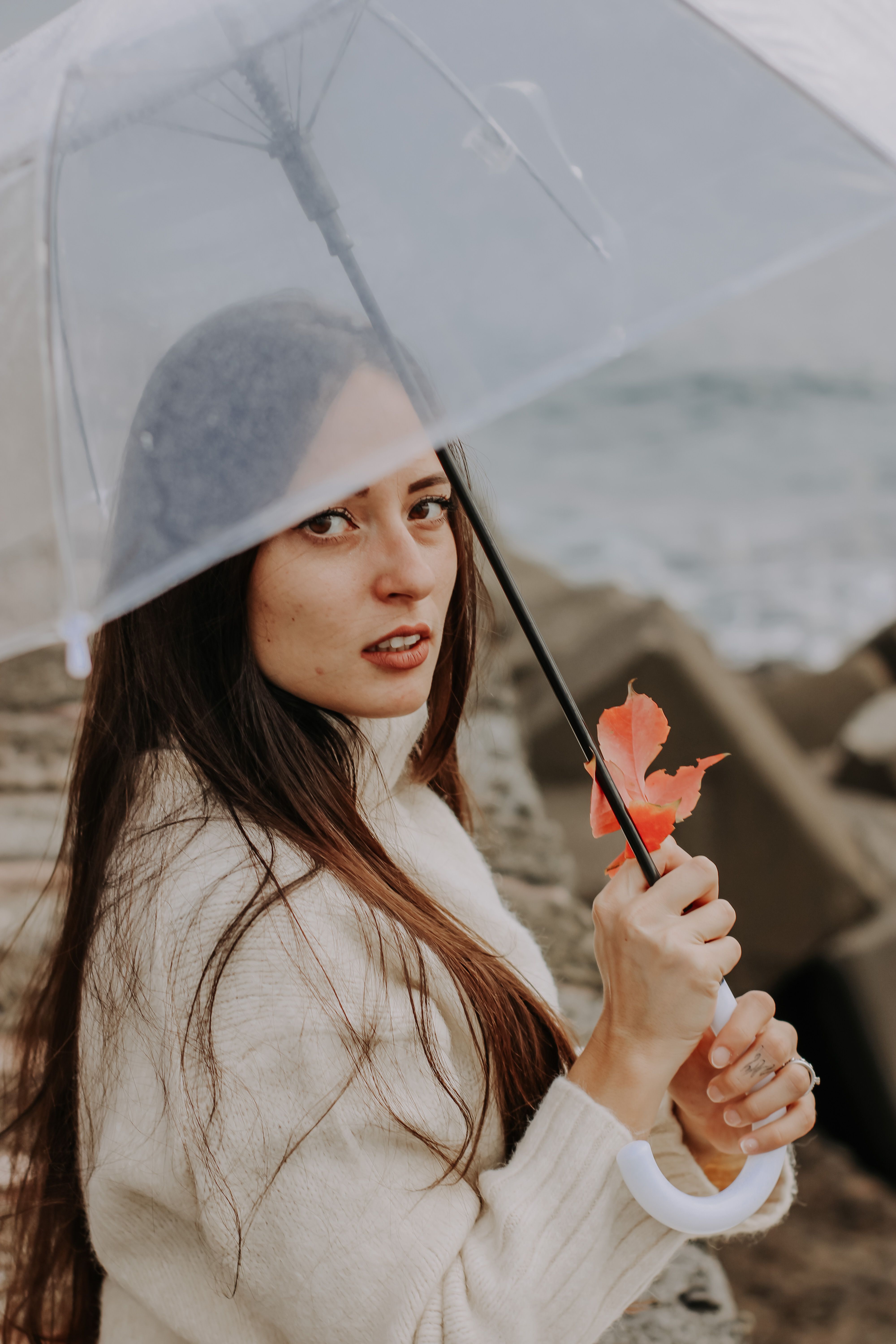 Woman Holding an Umbrella While Looking Over Her Shoulder · Free Stock ...