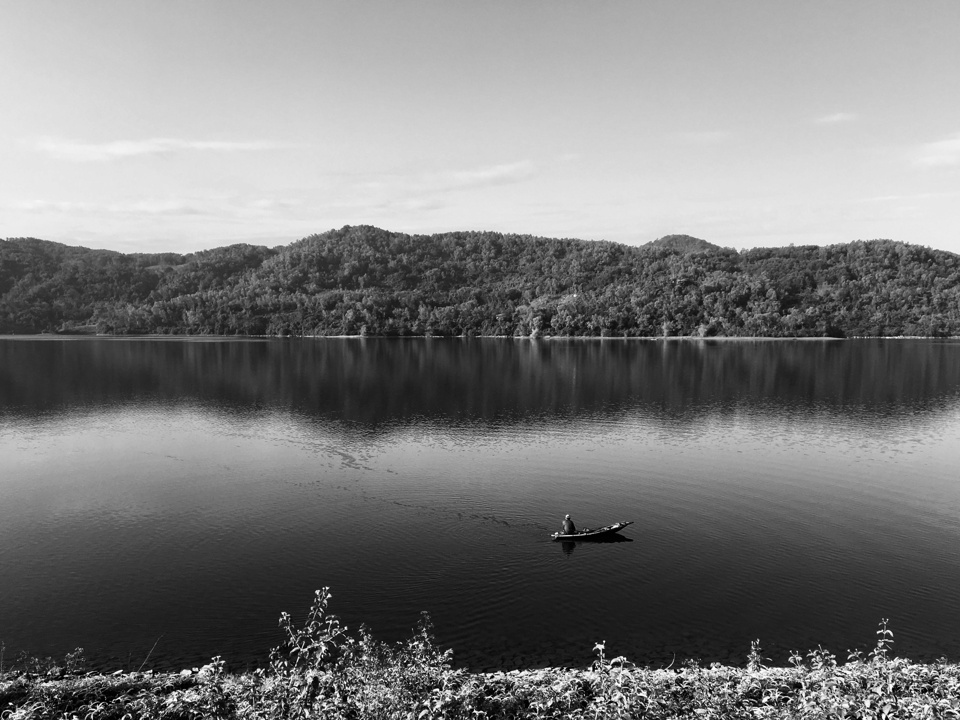 Grayscale Photo of a Boat · Free Stock Photo