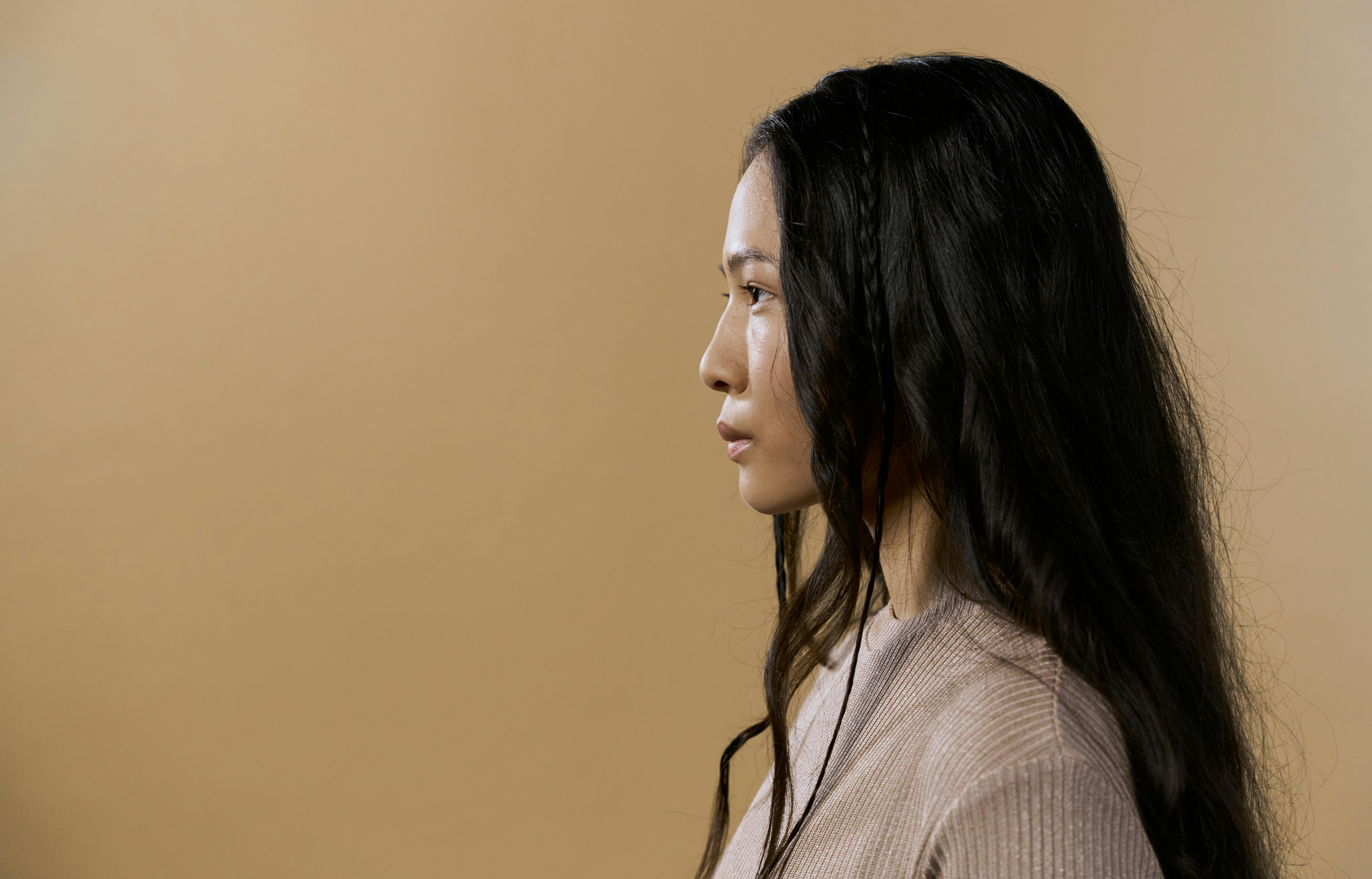 A Side View of a Woman with Wearing a Sweater · Free Stock Photo