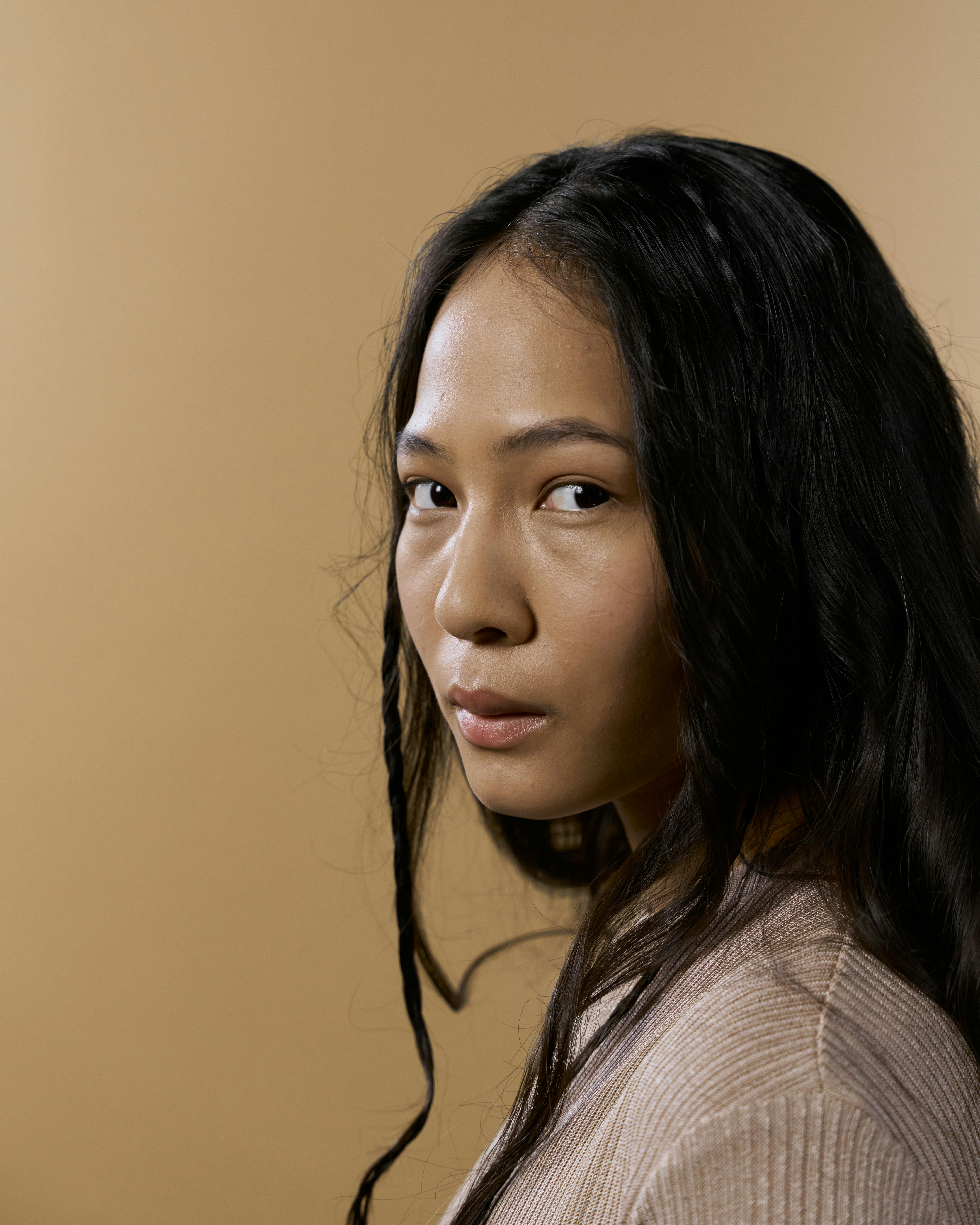 Close Up Photo of a Woman Looking Over Her Shoulder · Free Stock Photo