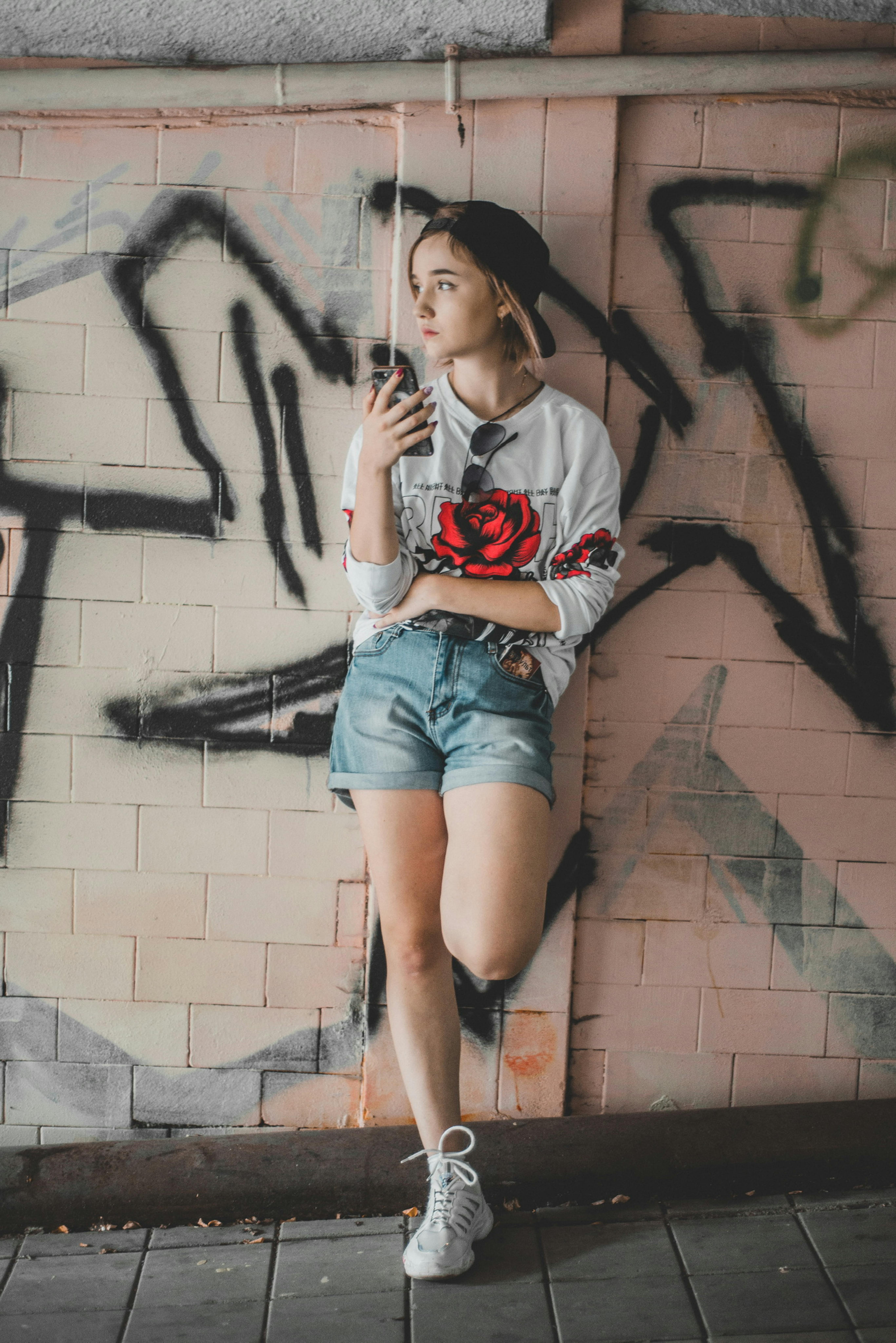 A Teenage Girl Leaning on Wall, Looking Away · Free Stock Photo