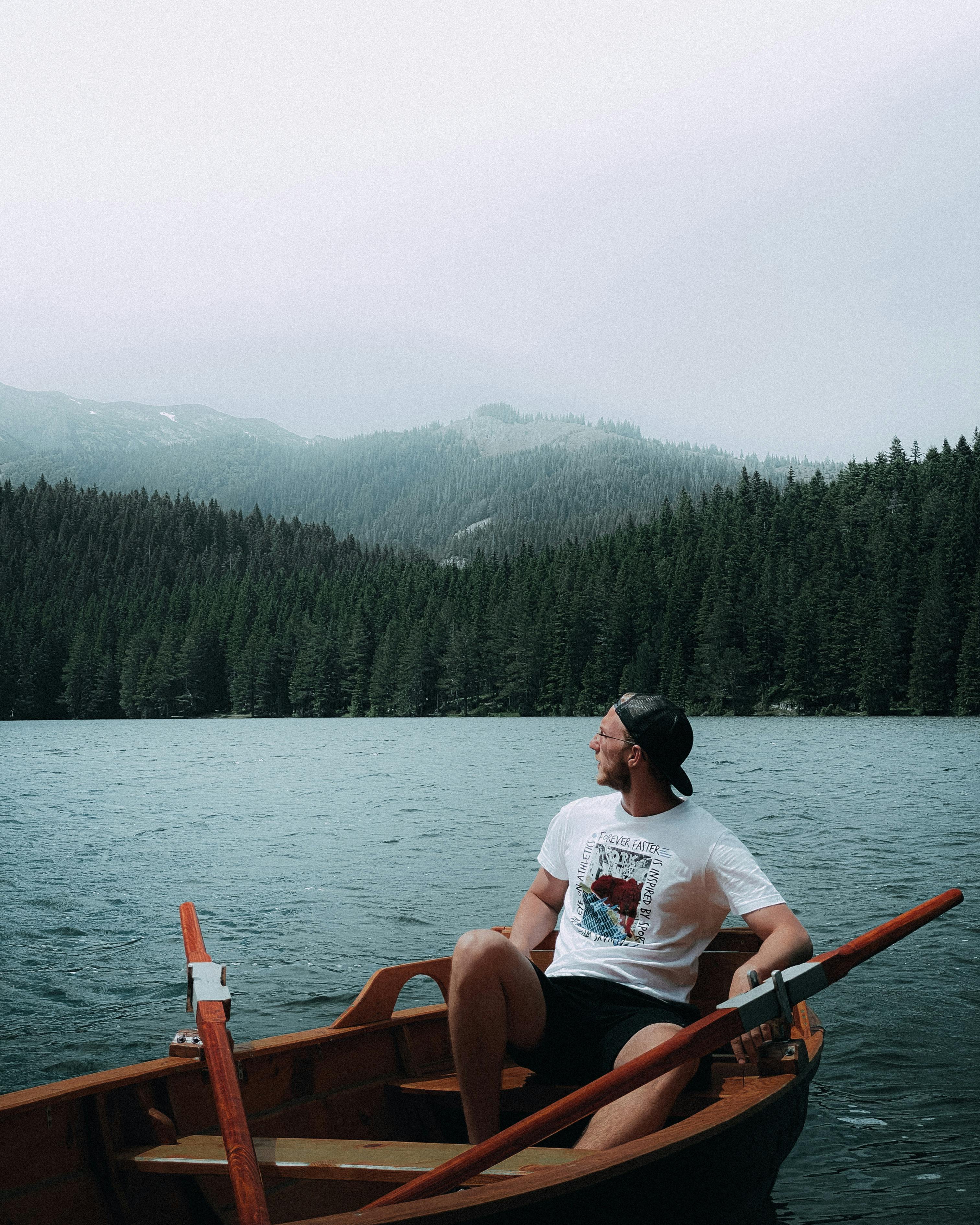 Man Sitting in Boat on Lake · Free Stock Photo