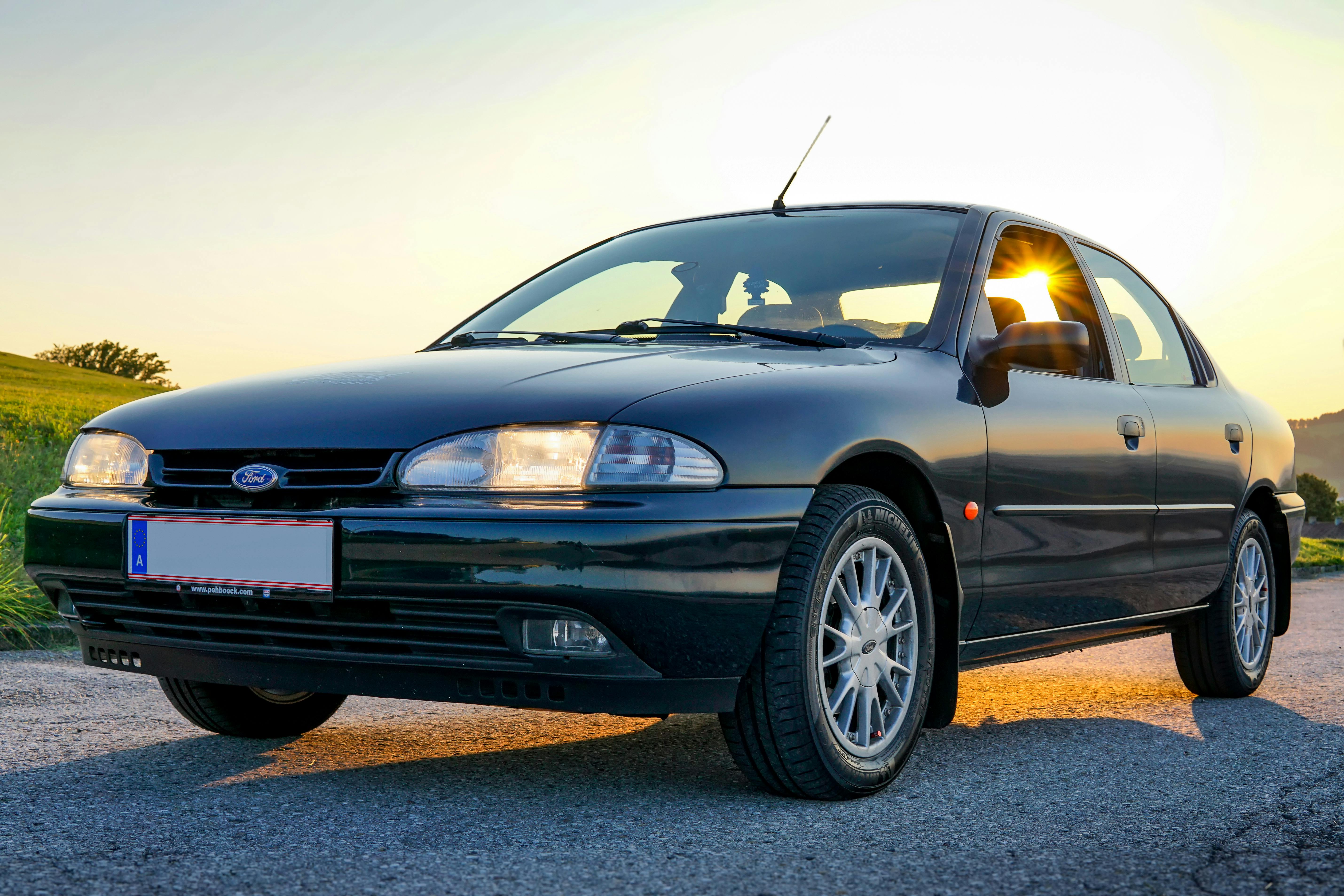 A Black Ford Car Parked on the Road · Free Stock Photo