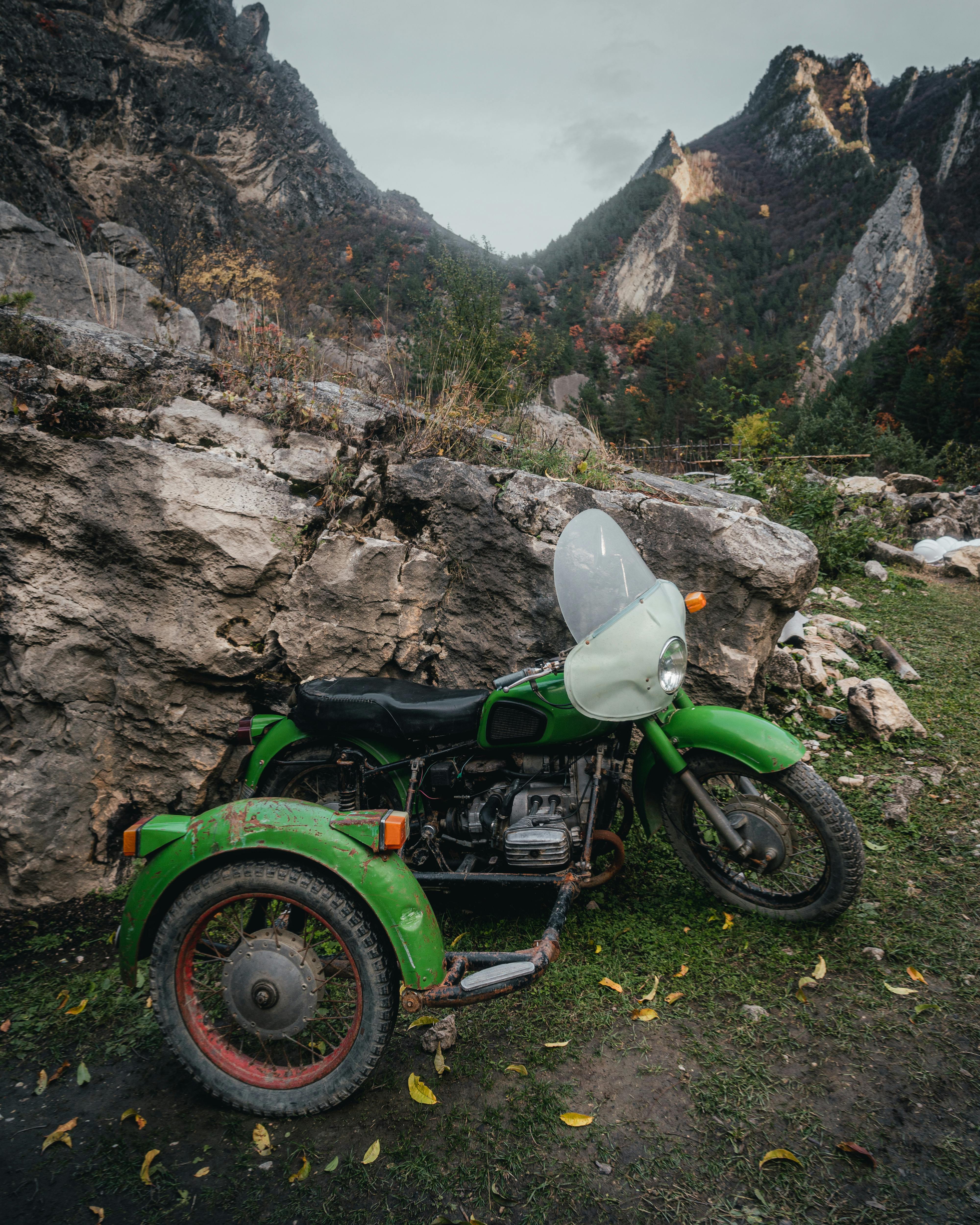 A Dirt Bike Parked Beside Big Rocks · Free Stock Photo