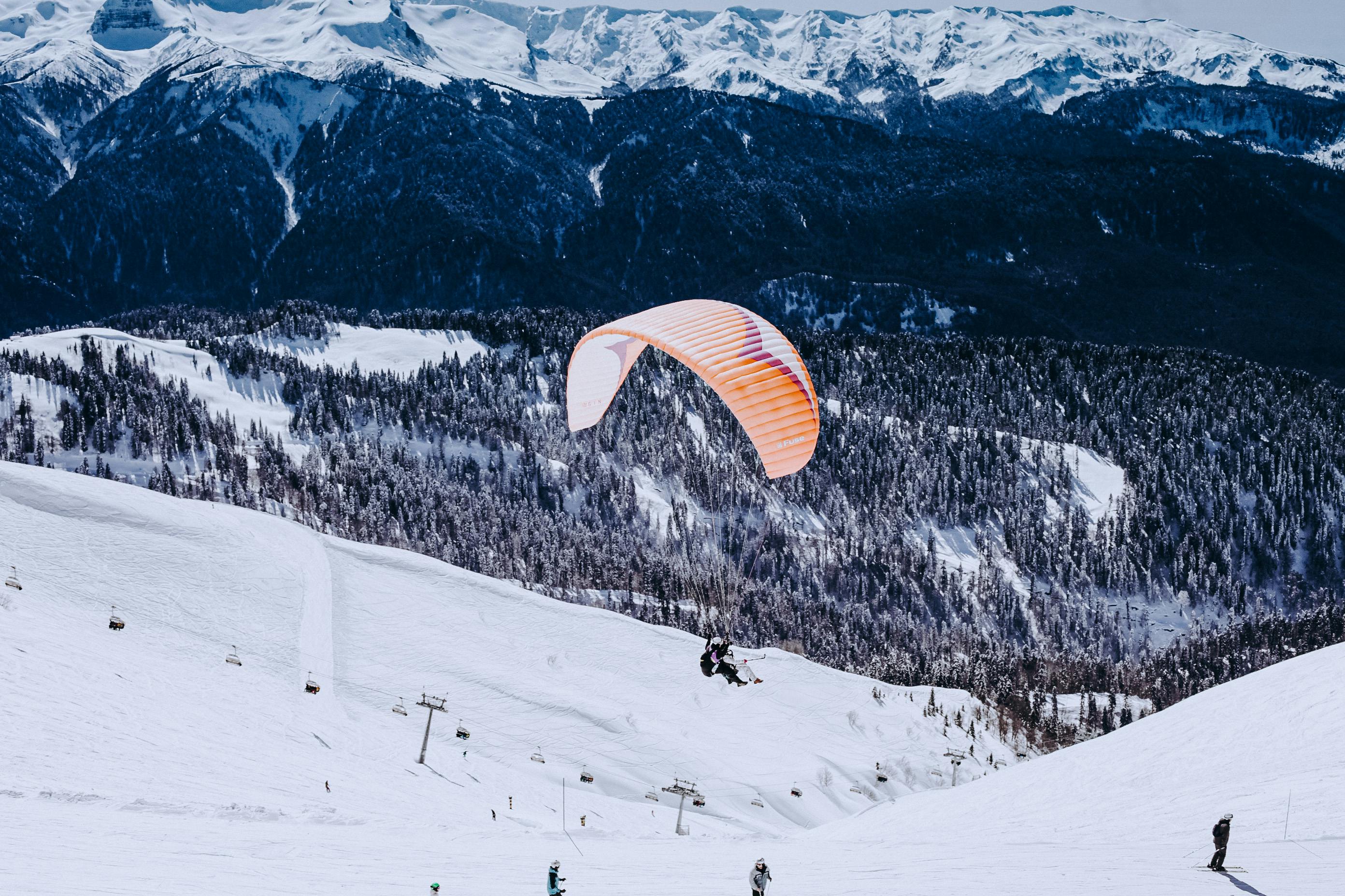 A Man Paragliding During Winter · Free Stock Photo