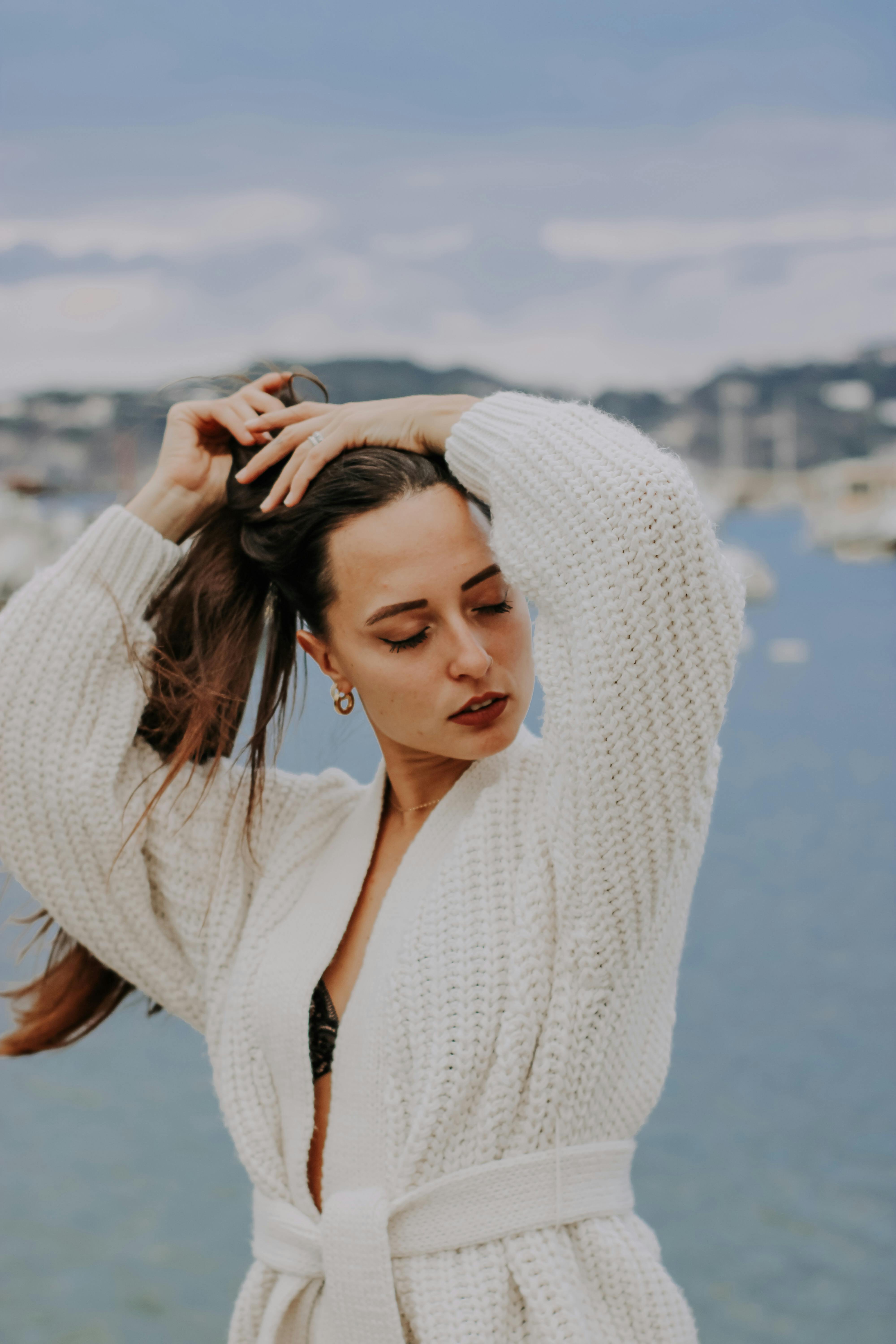A Woman in White Robe Standing Beside Sheer Curtain · Free Stock Photo