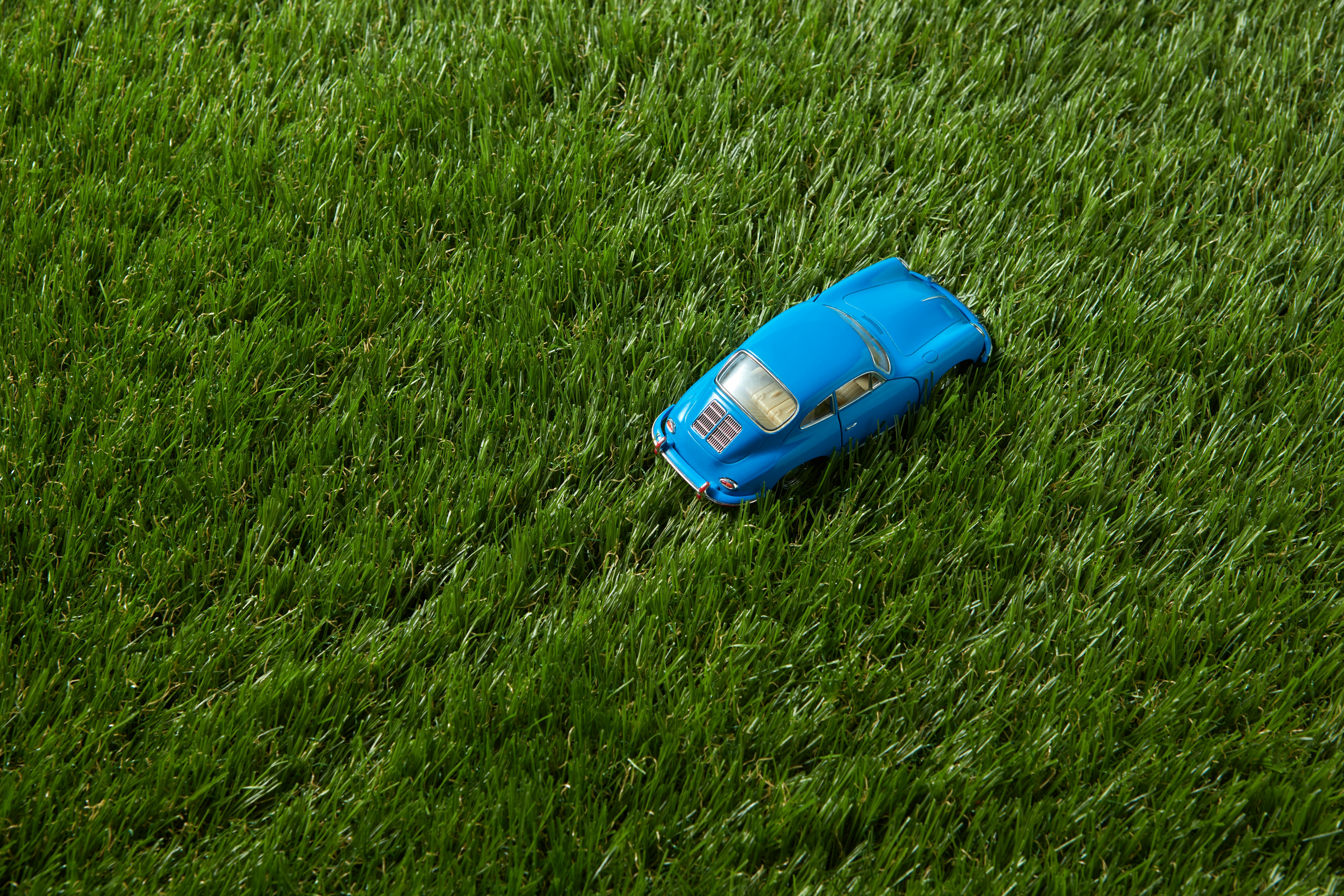 A Blue Toy Car on Green Grass · Free Stock Photo