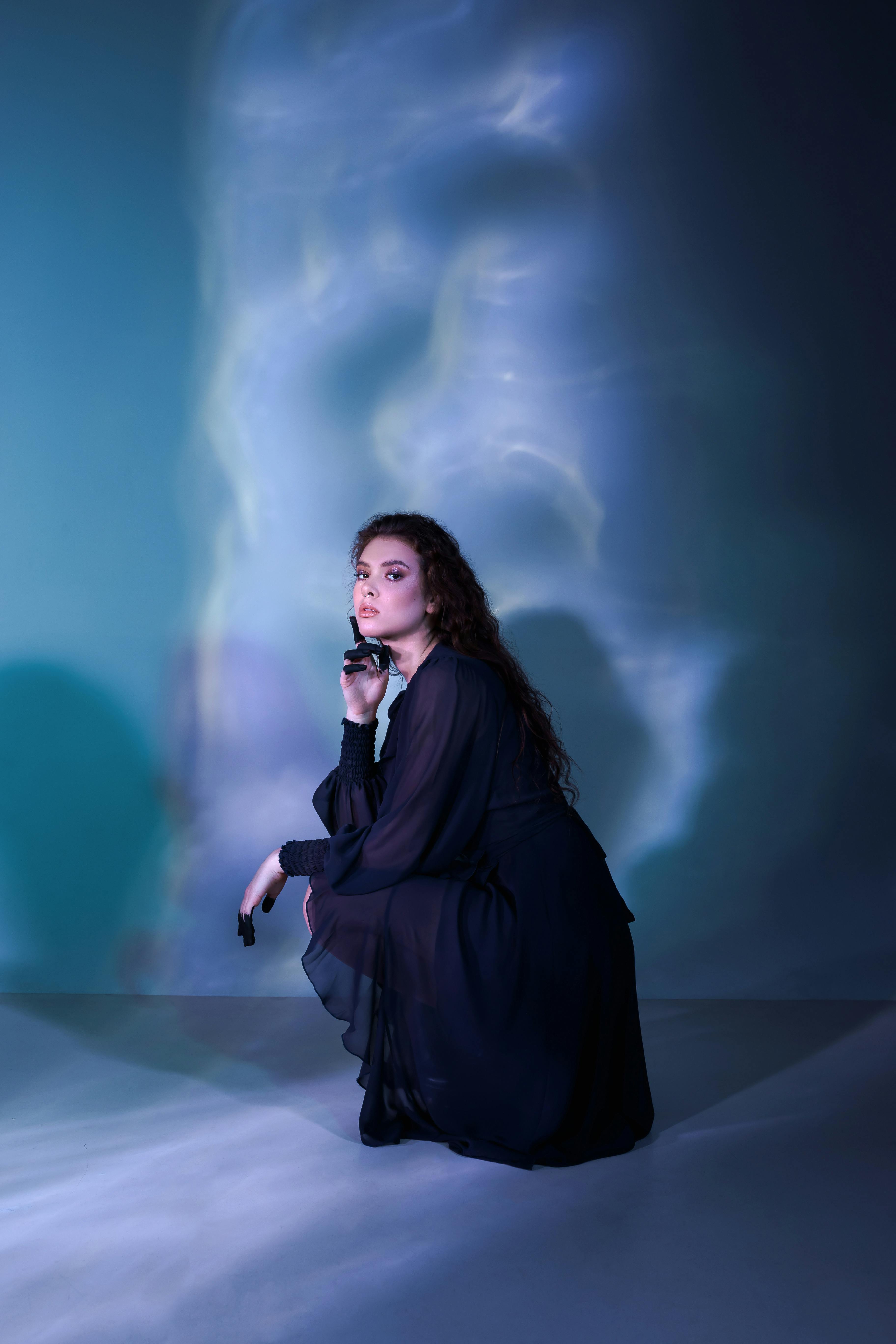 Woman Crouching on Rock · Free Stock Photo