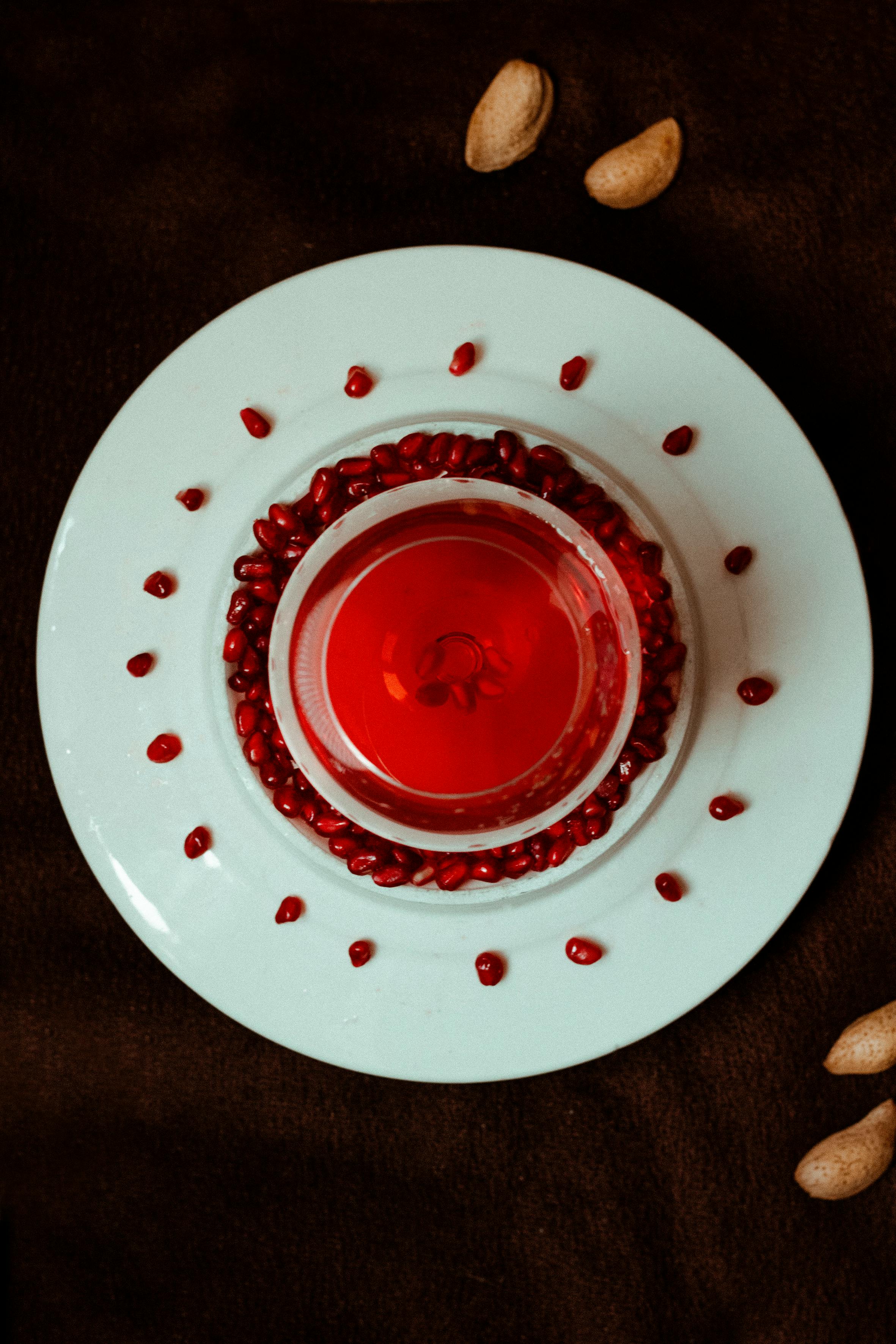 Red Gelatin Surrounded with Pomegranate Seeds on White Plate · Free ...
