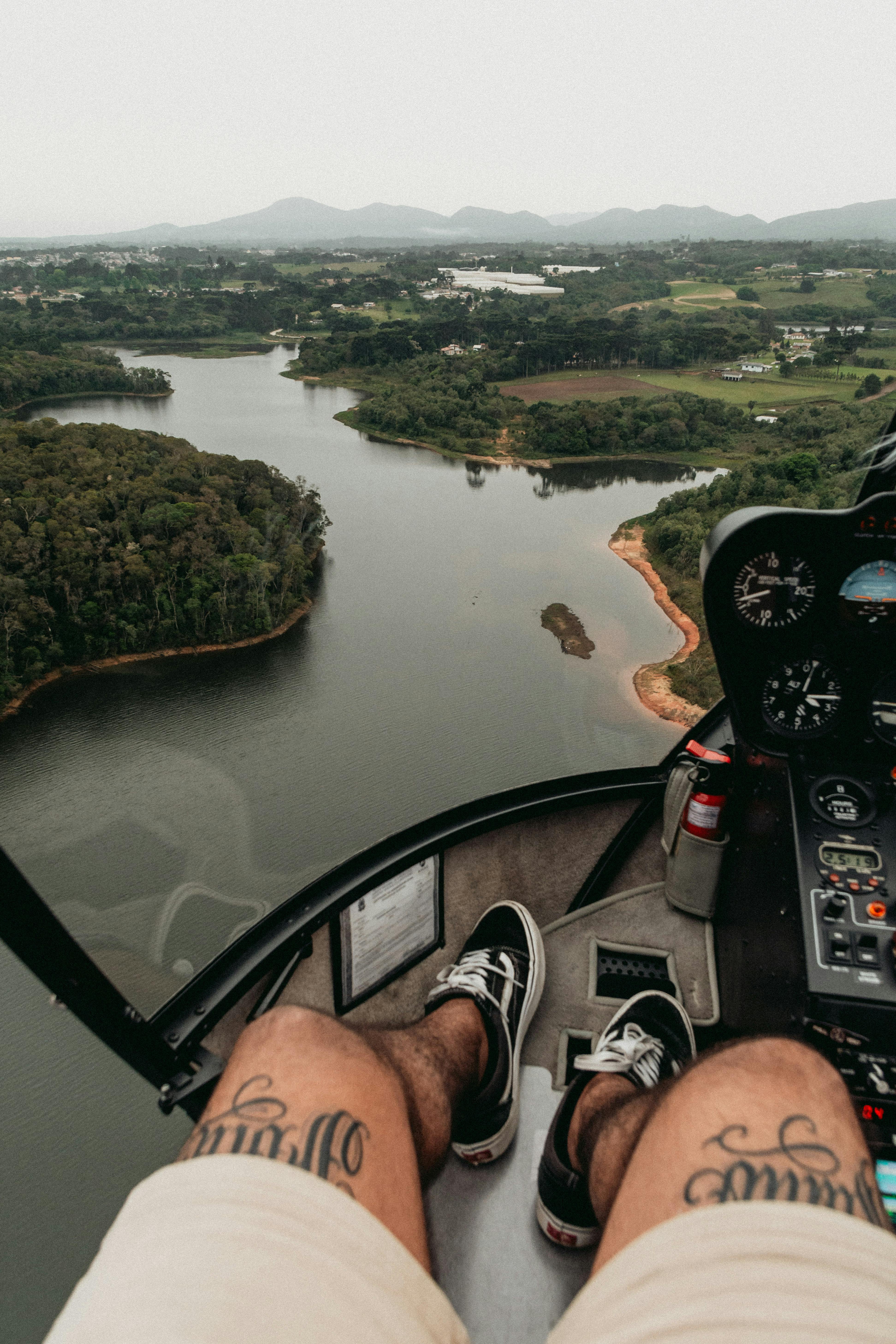 Man in Helicopter Above River · Free Stock Photo
