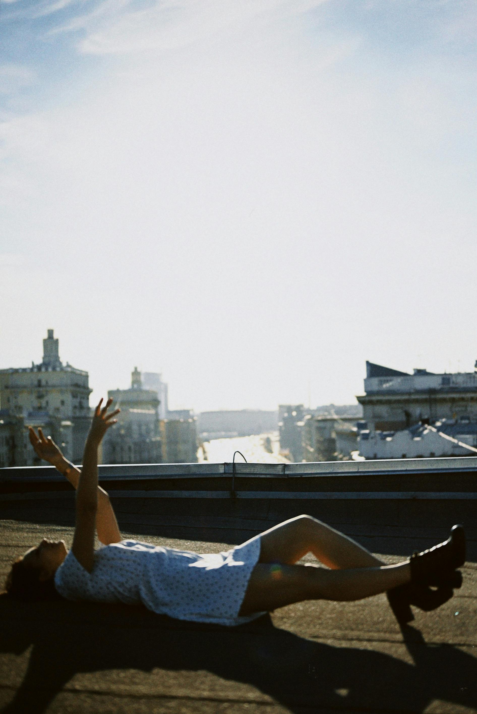 Woman Standing on Rooftop Putting Hands in the Air Under Clear Sky ...