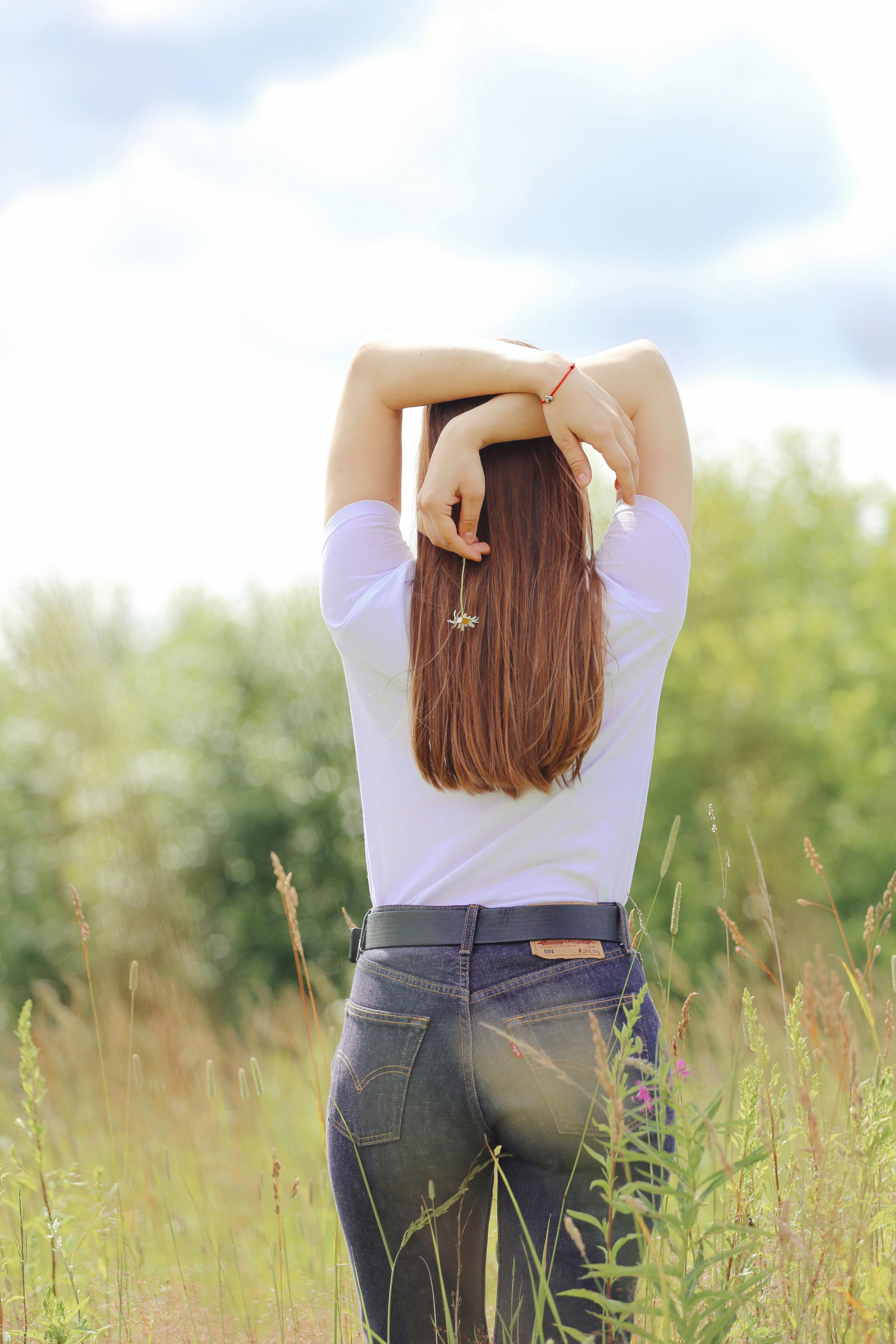 Back View of a Woman Holding her Back · Free Stock Photo
