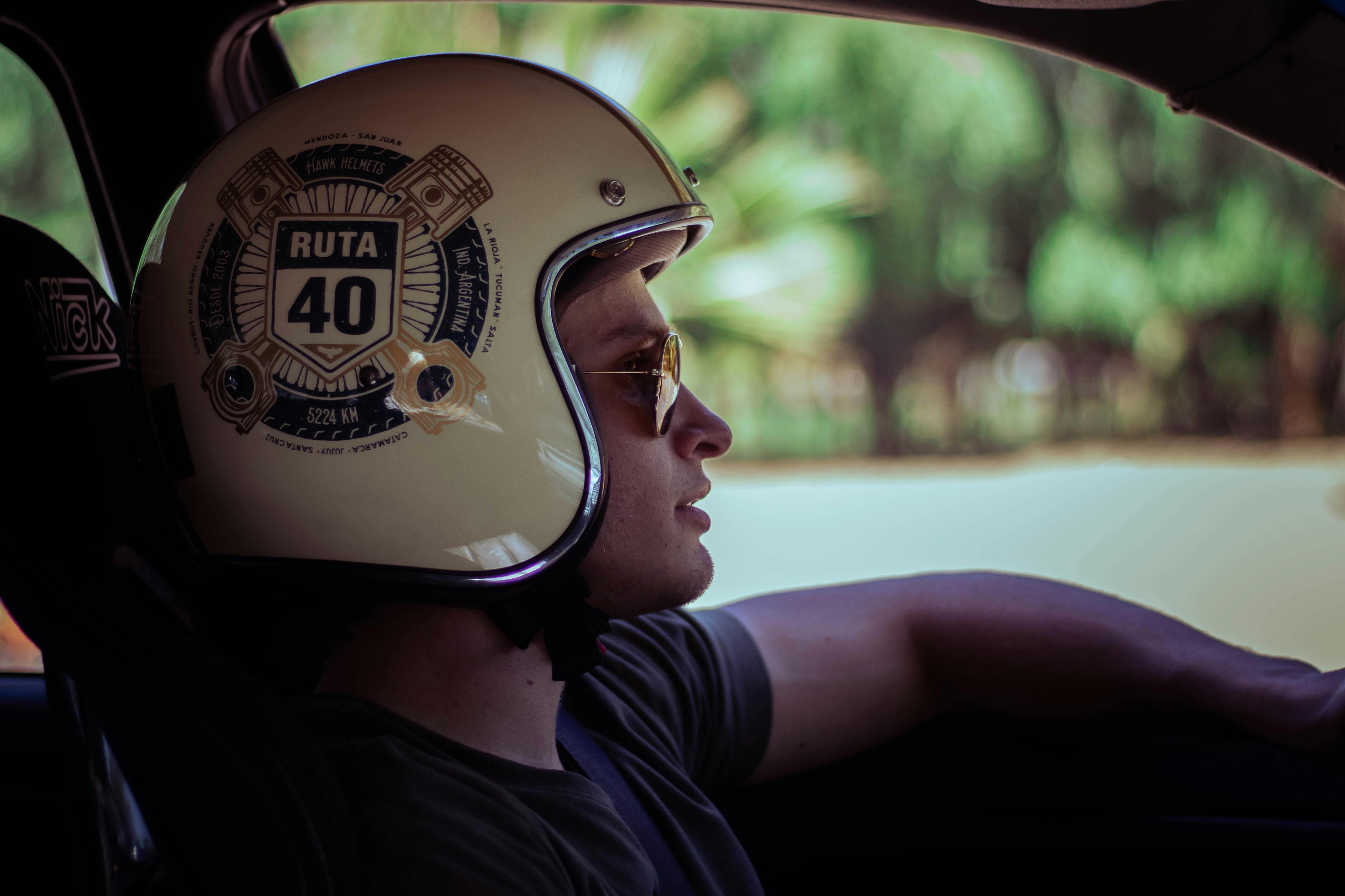 Man Driving a Car Wearing a Helmet · Free Stock Photo
