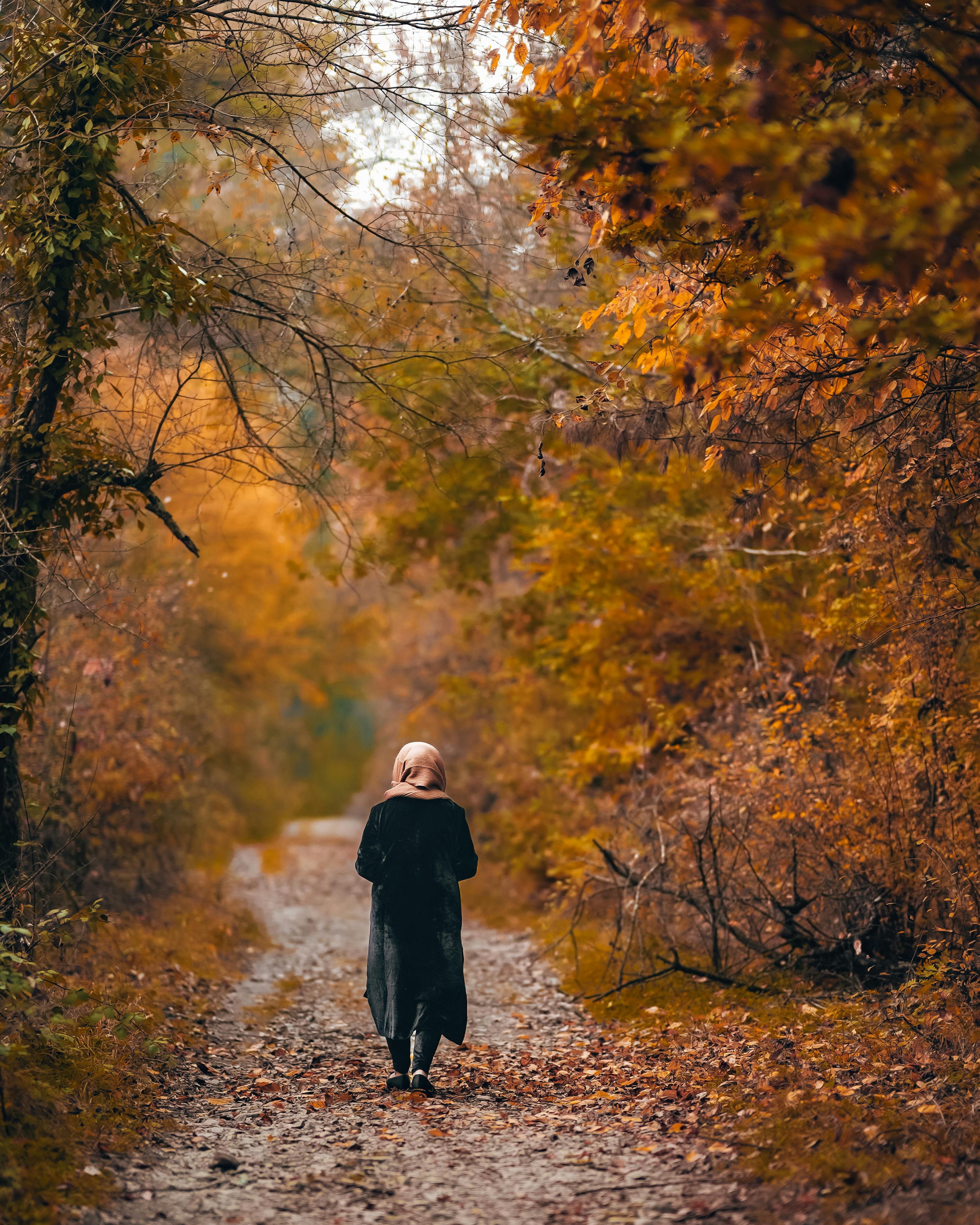 Woman Walking on Unpaved Path · Free Stock Photo