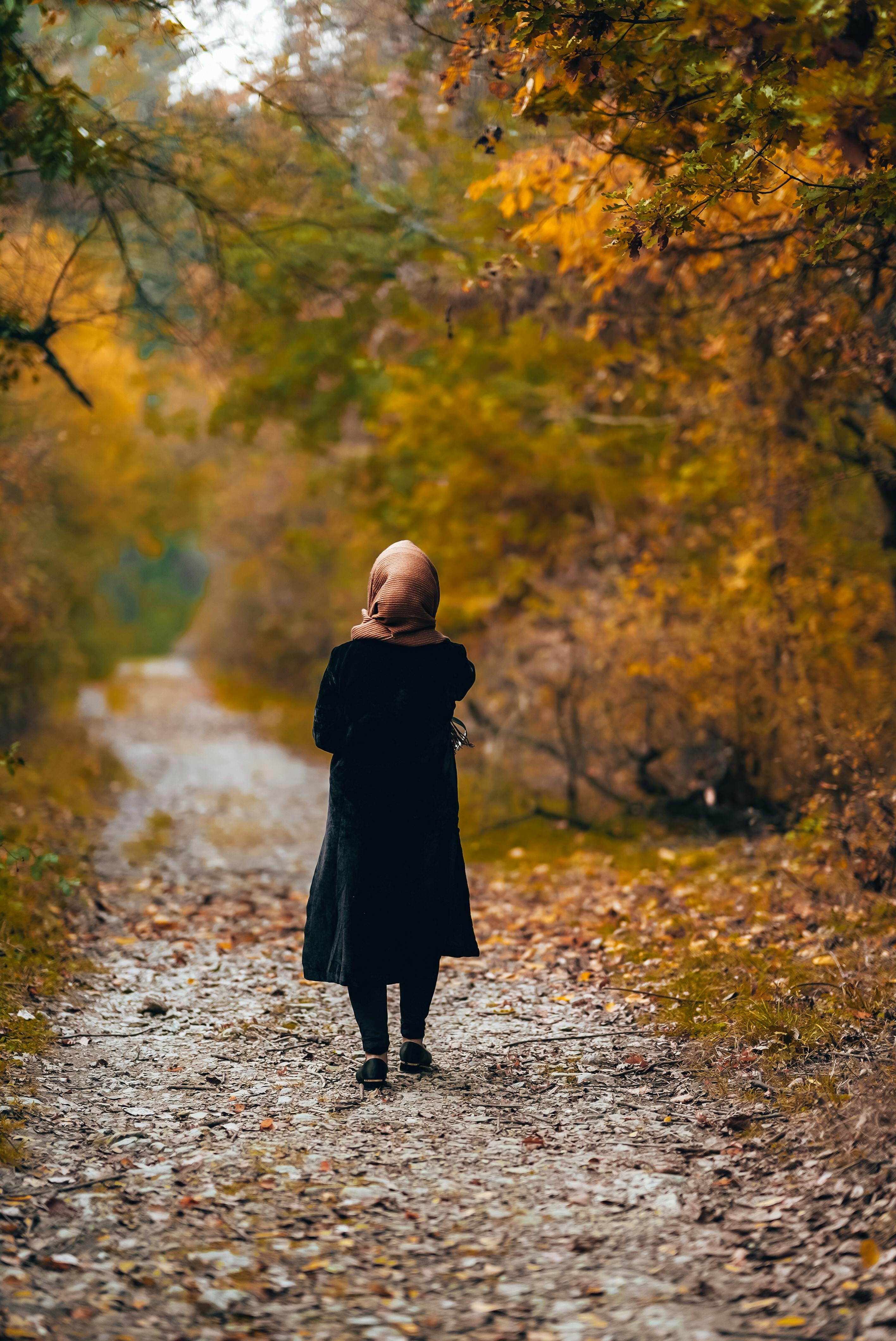 Woman Walking on Unpaved Path · Free Stock Photo