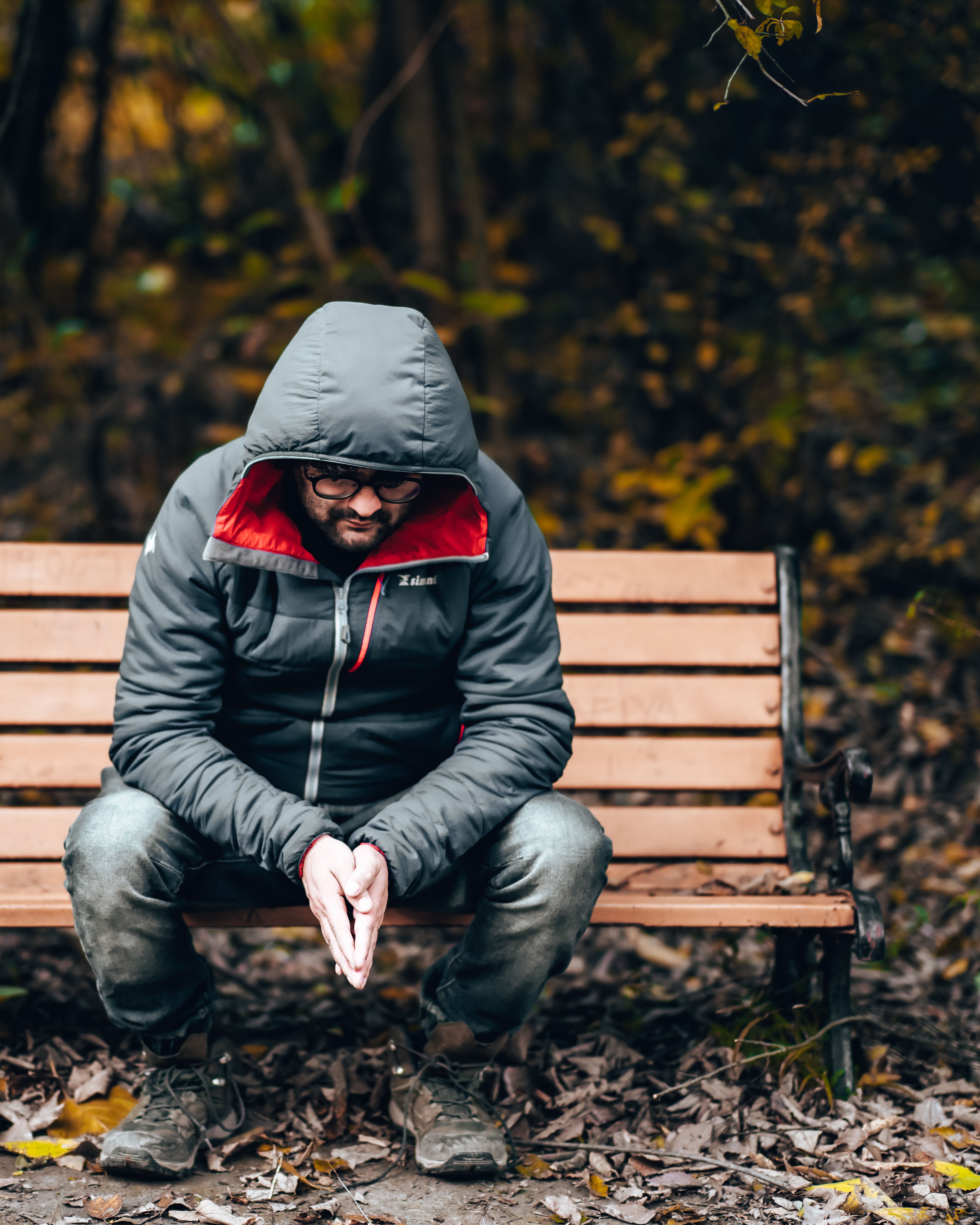 Man Wearing Jacket Sitting on Bench · Free Stock Photo
