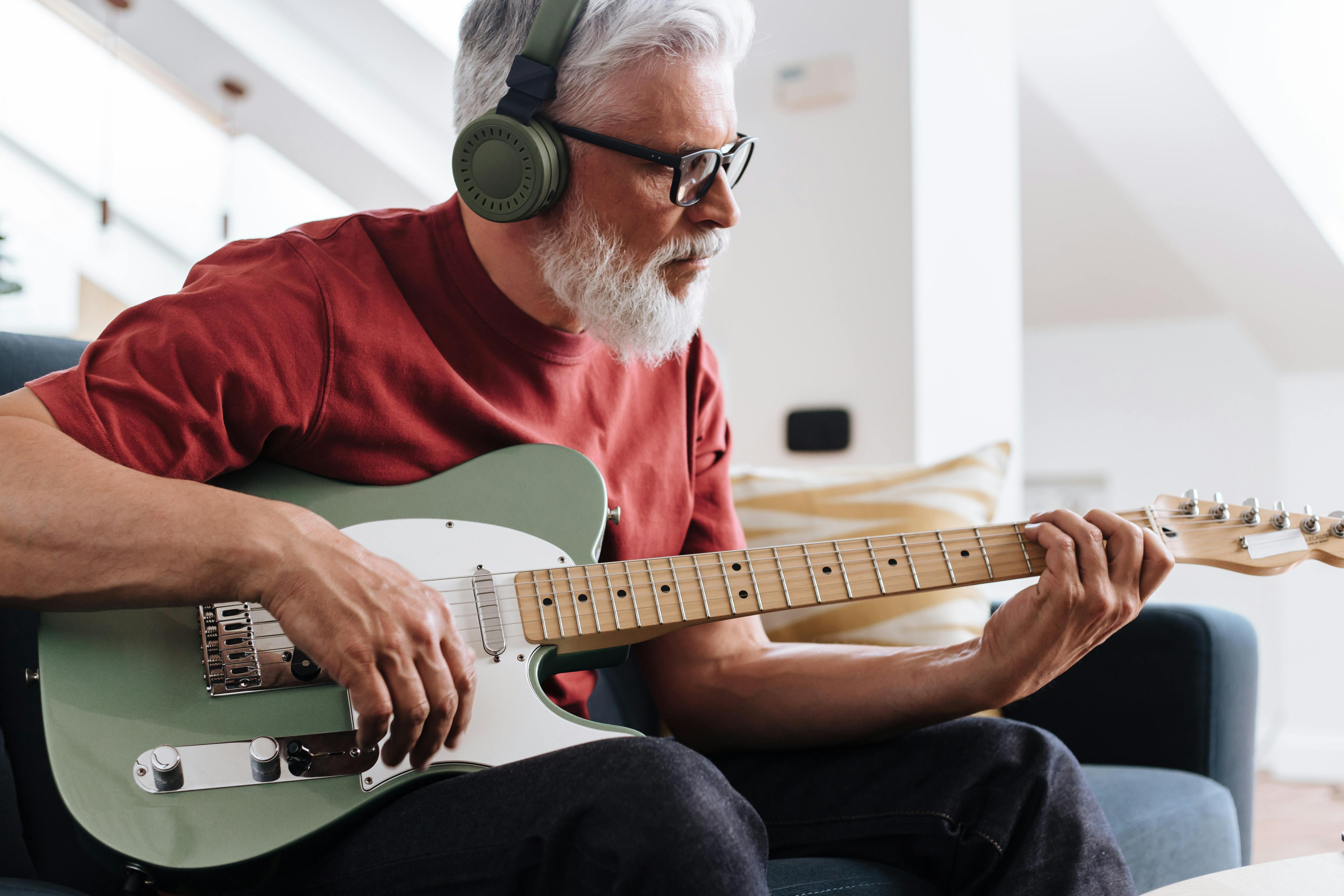 Elderly Man Playing on Electric Guitar · Free Stock Photo