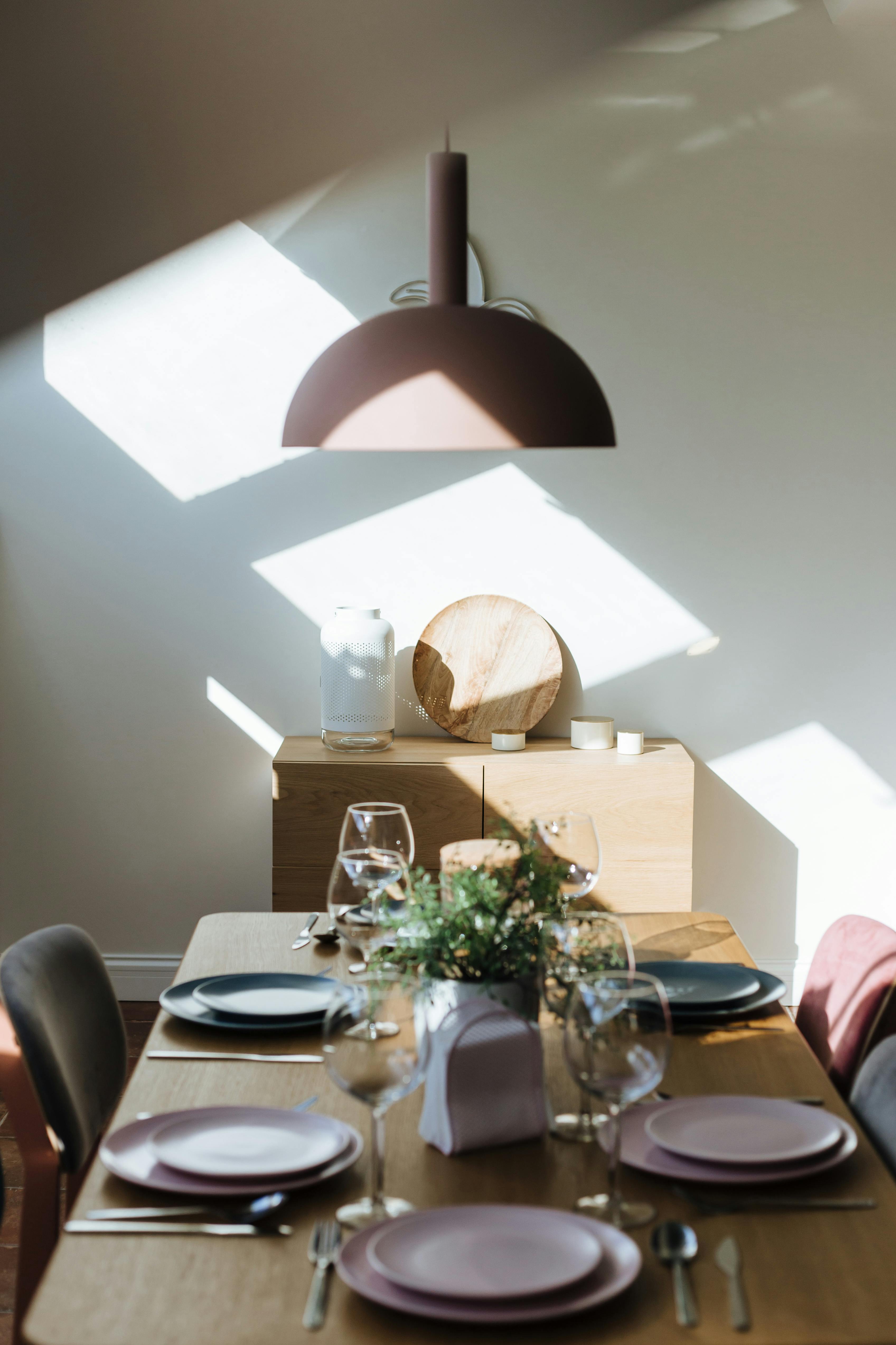 Dining Room with Lamp and Table with Plates and Cutlery · Free Stock Photo