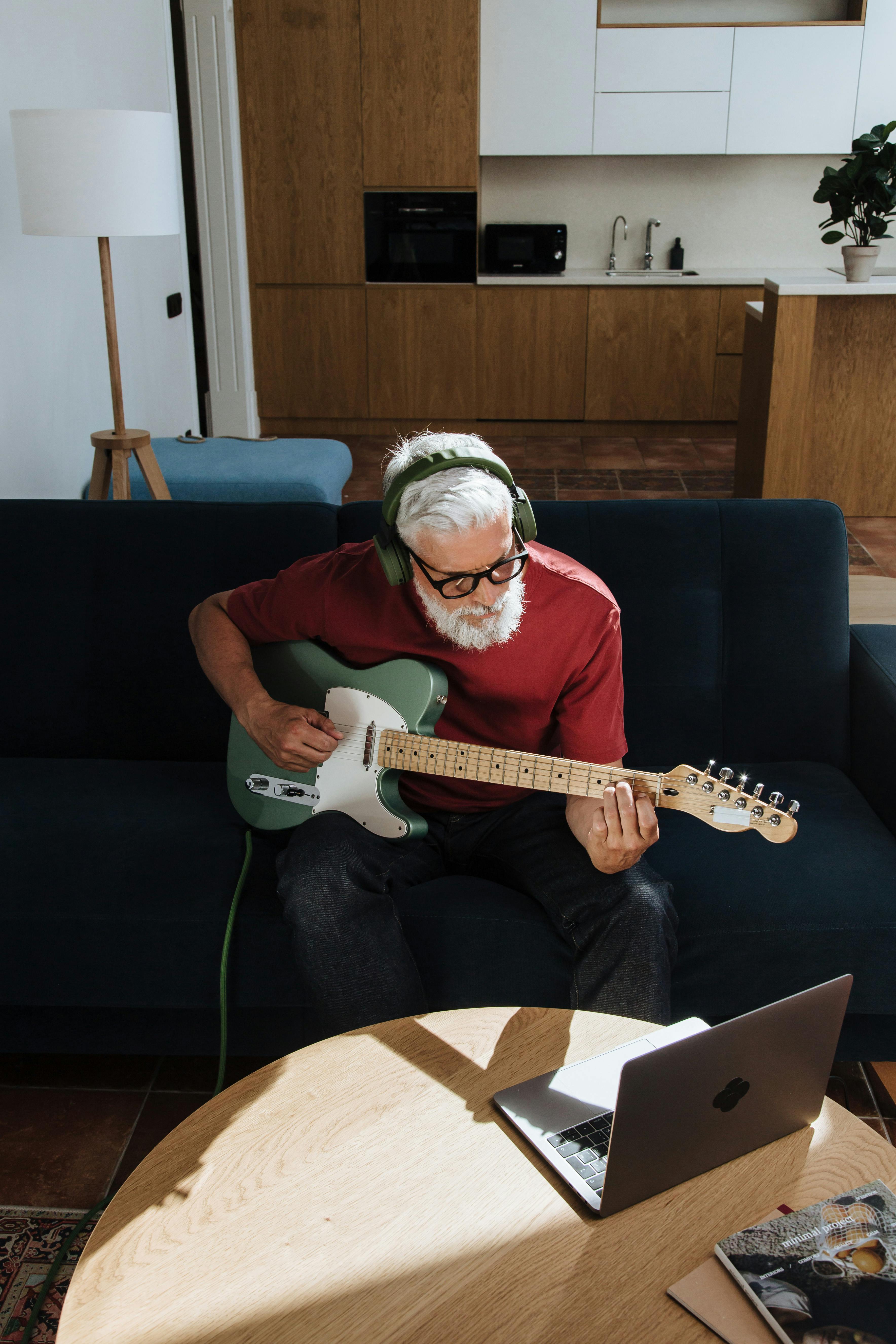 Elderly Man Playing on Electric Guitar · Free Stock Photo