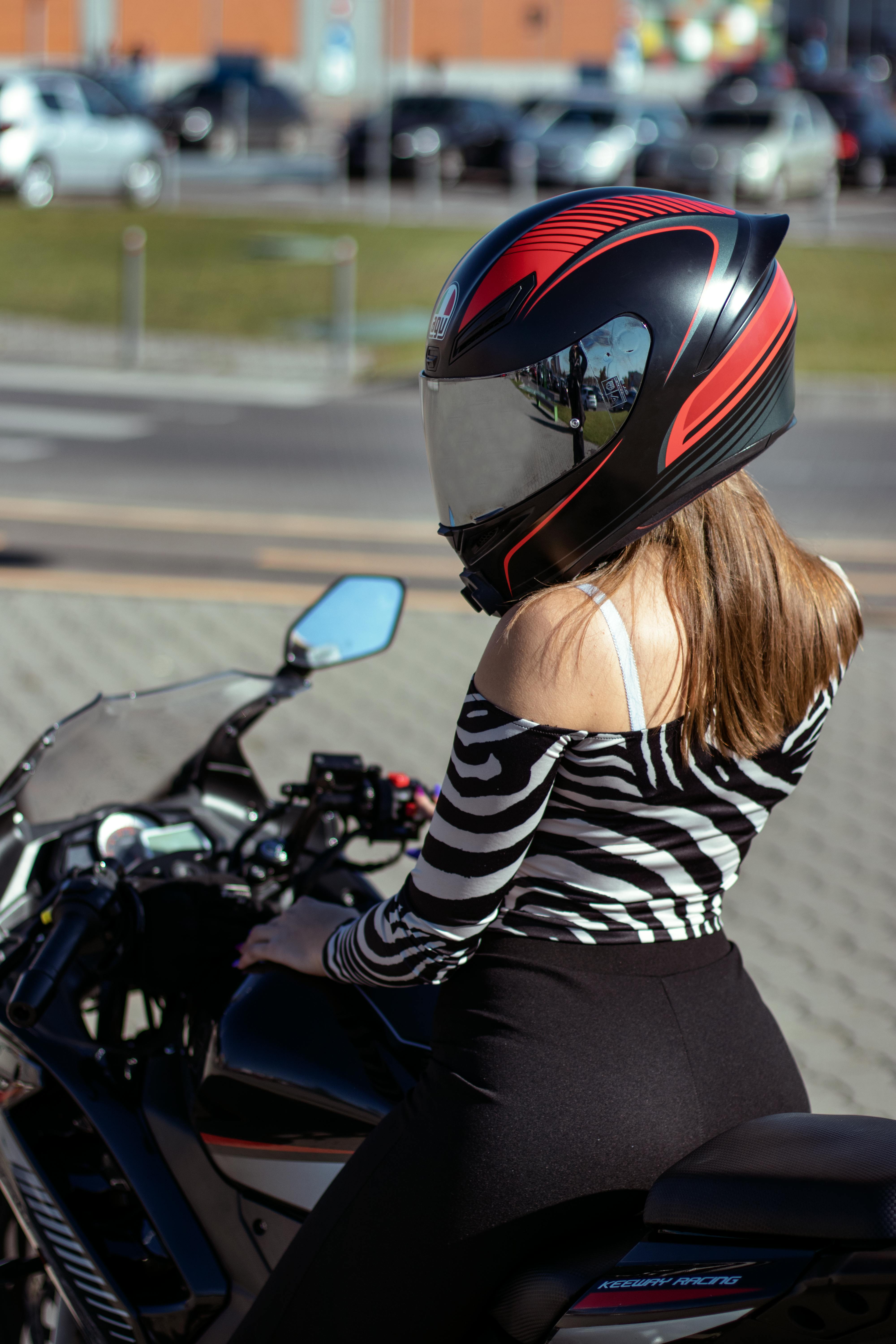 Woman in Motorcycle on Parking Lot · Free Stock Photo