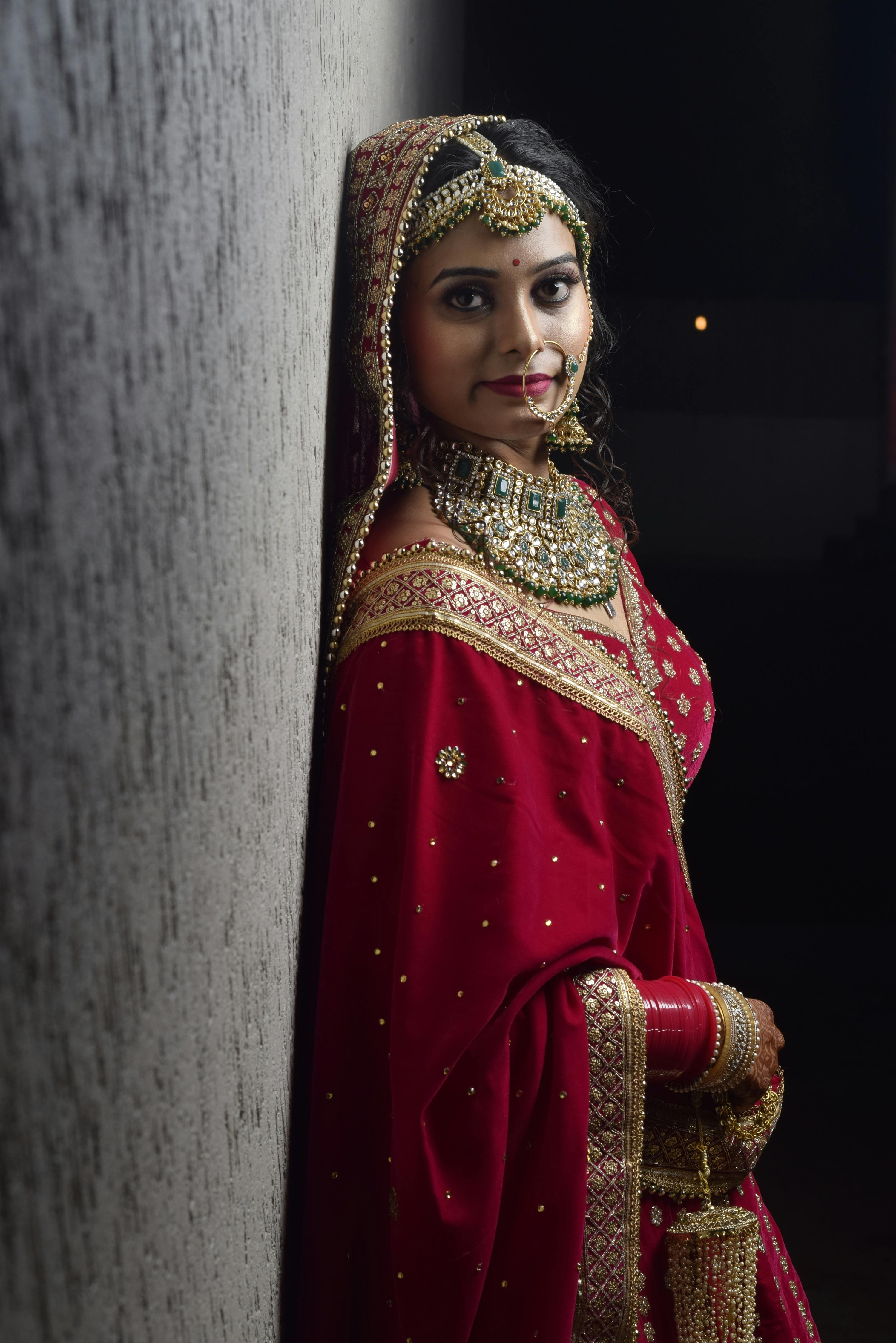 Hindu Woman in White Dress Leaning against Ladder · Free Stock Photo