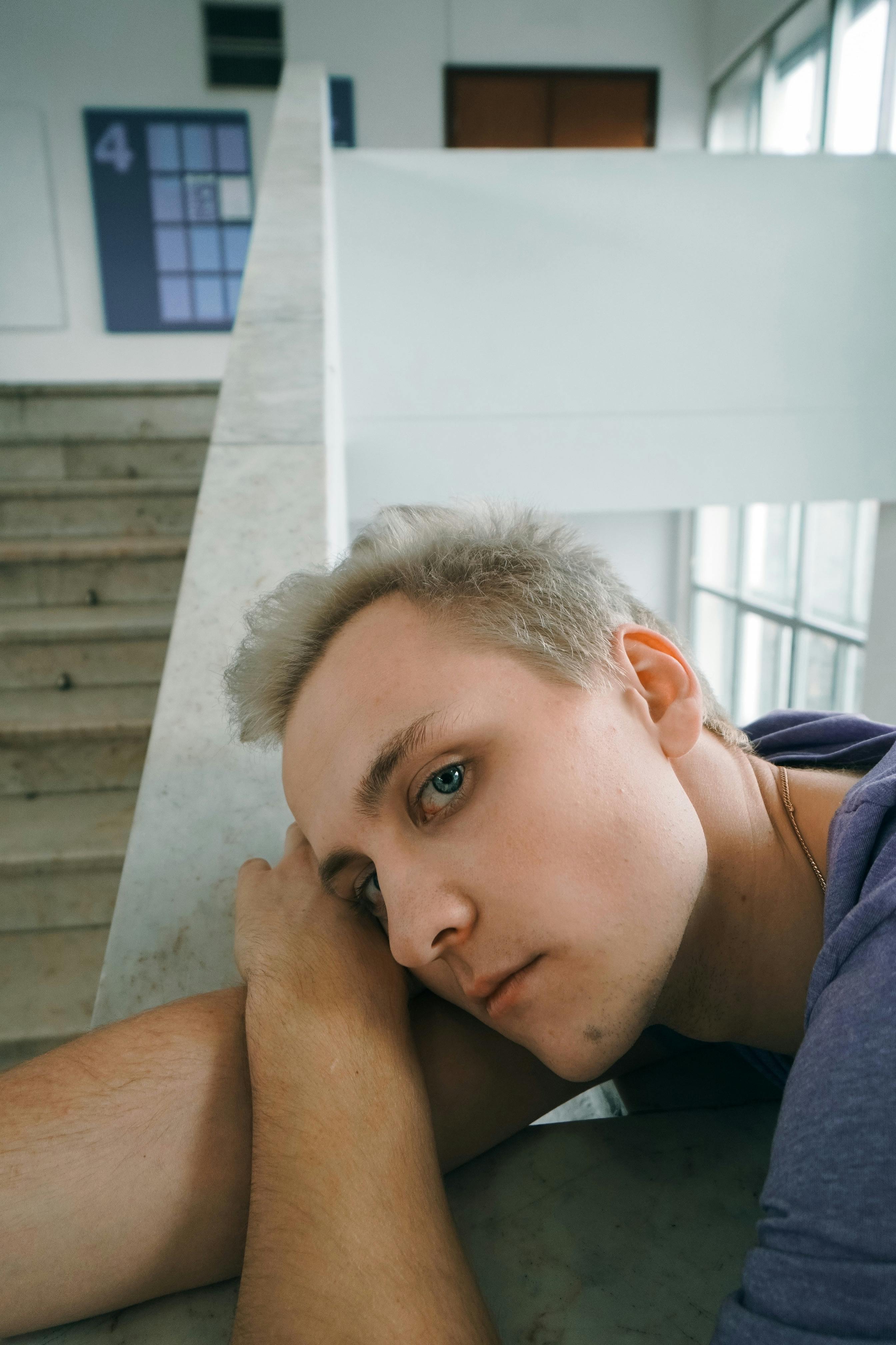 Man Laying on Staircase Railing · Free Stock Photo