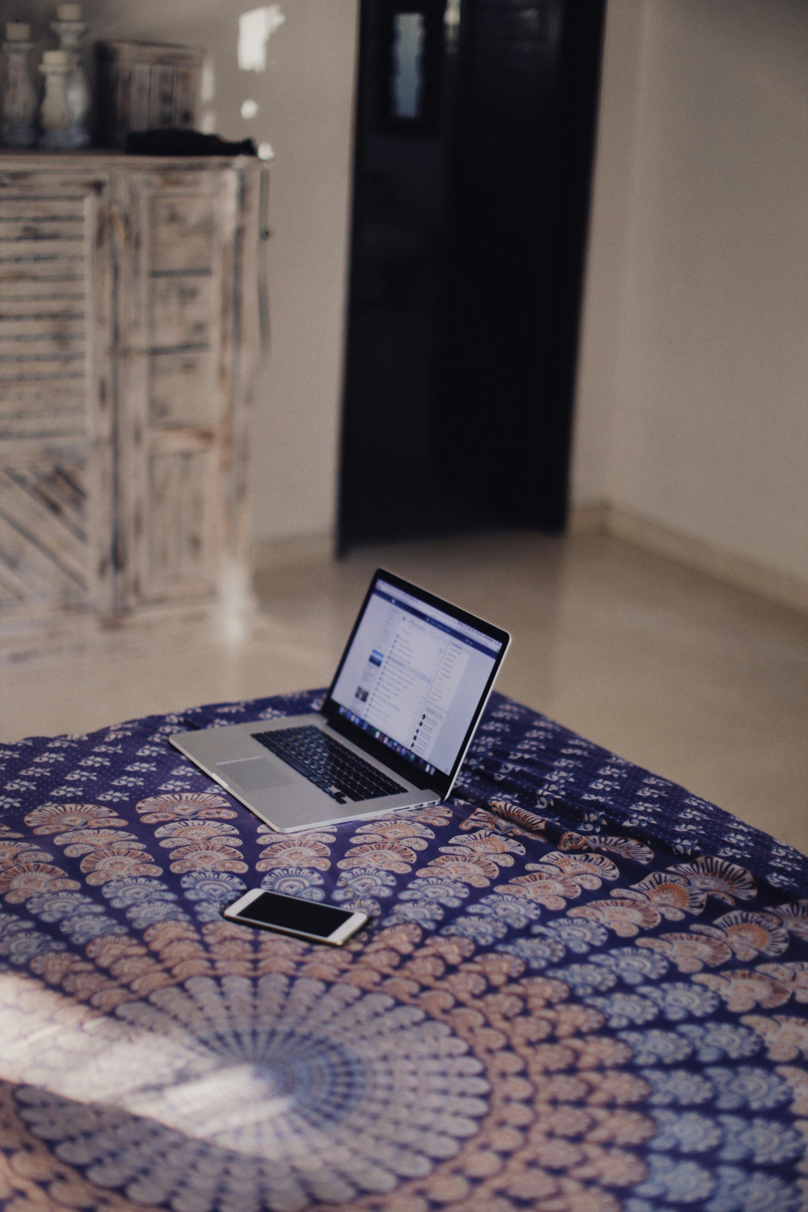 Computer laptop and Cellphone on Rug · Free Stock Photo