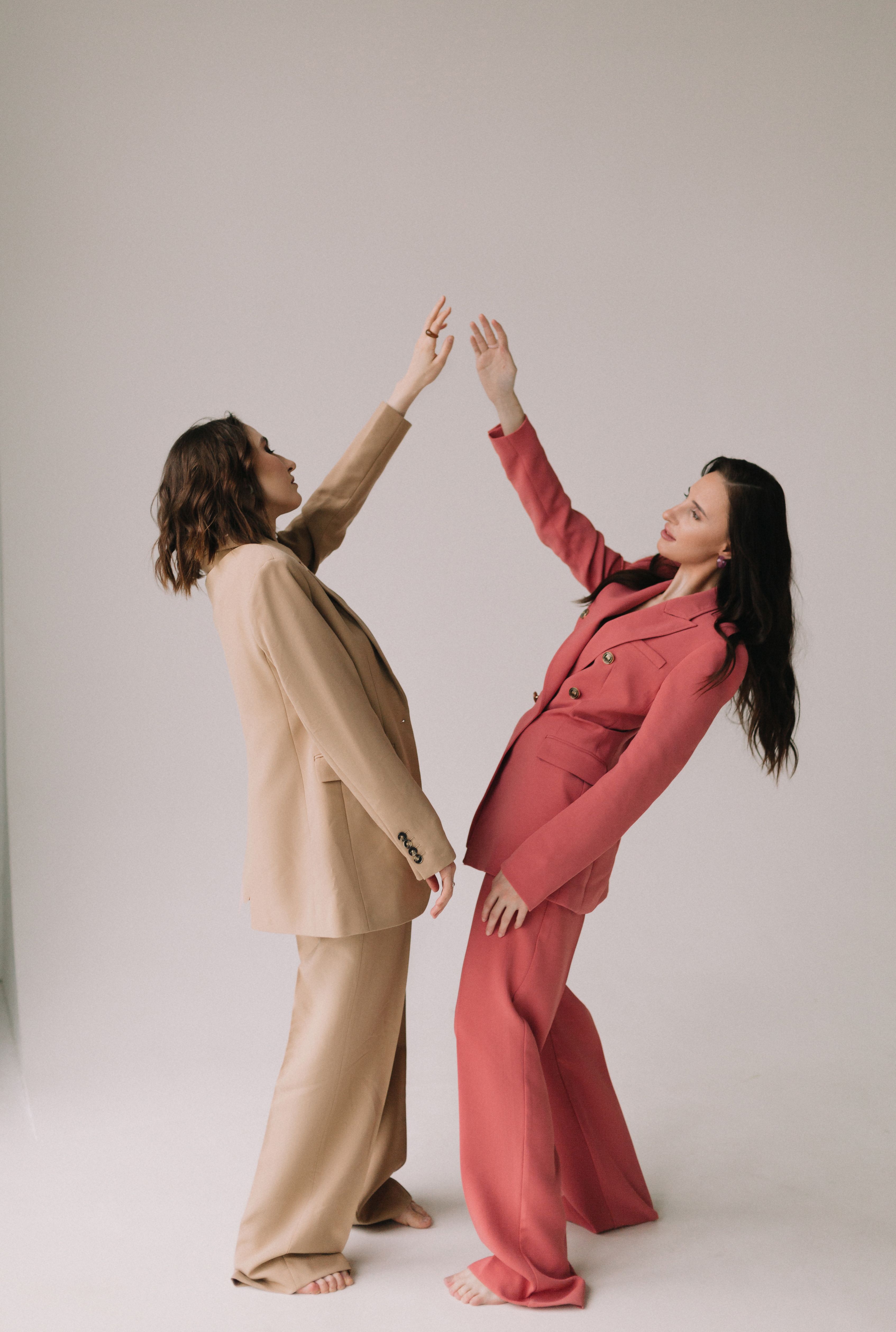 Women in Oversized Clothes Striking Symmetrical Poses · Free Stock Photo
