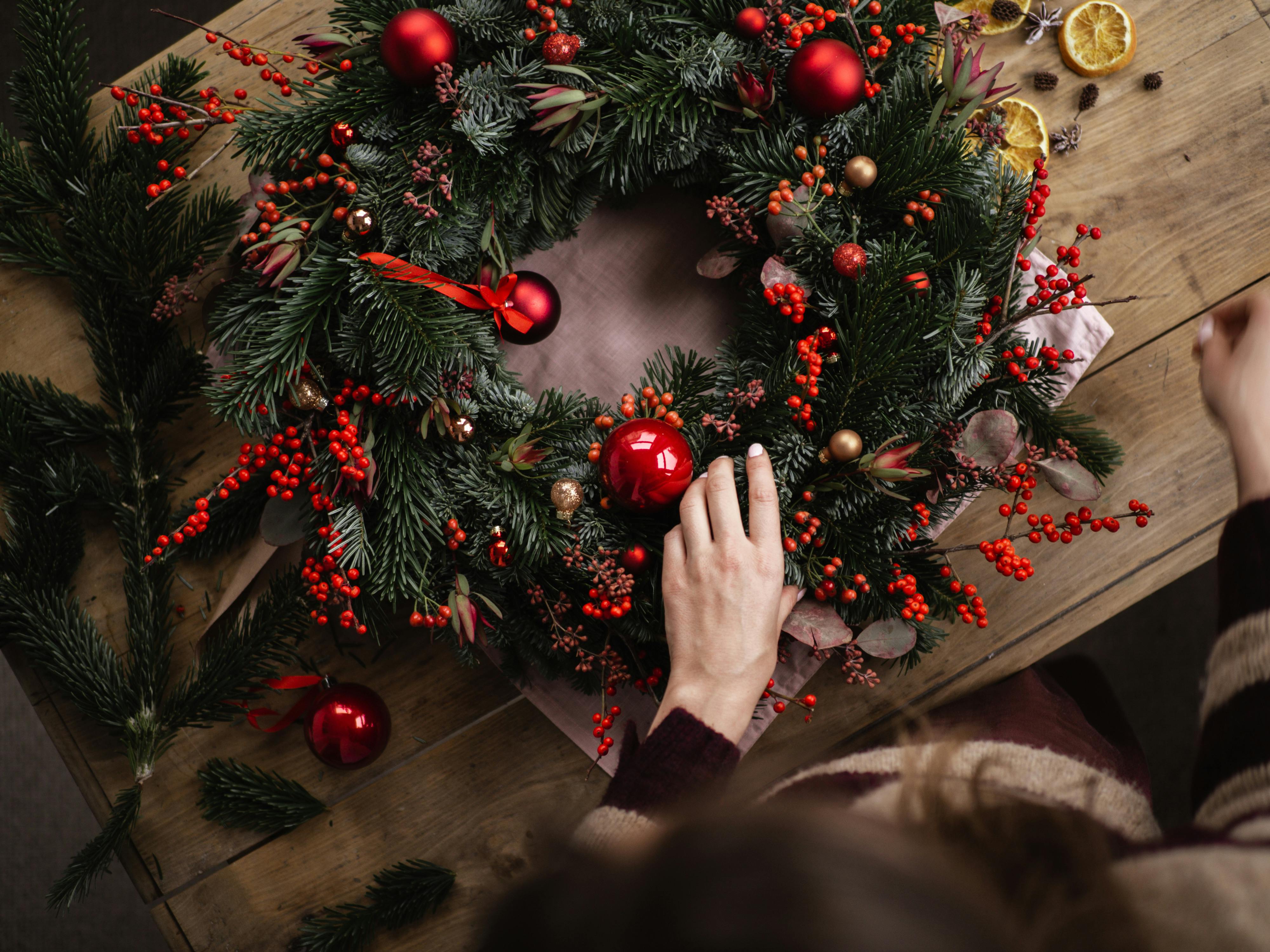 Person Making Christmas Wreath · Free Stock Photo