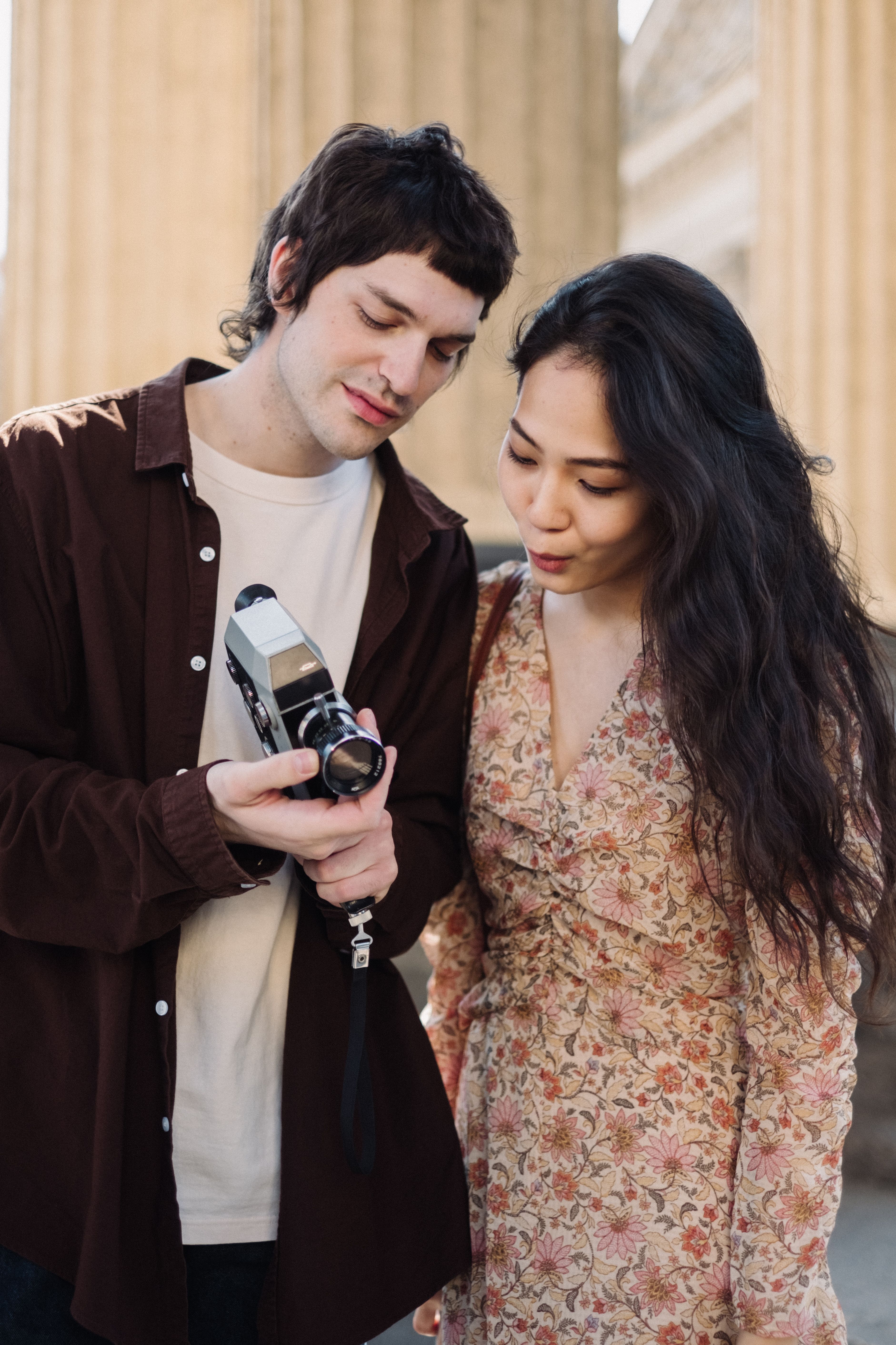 Man and Woman Looking at Analog Camera · Free Stock Photo