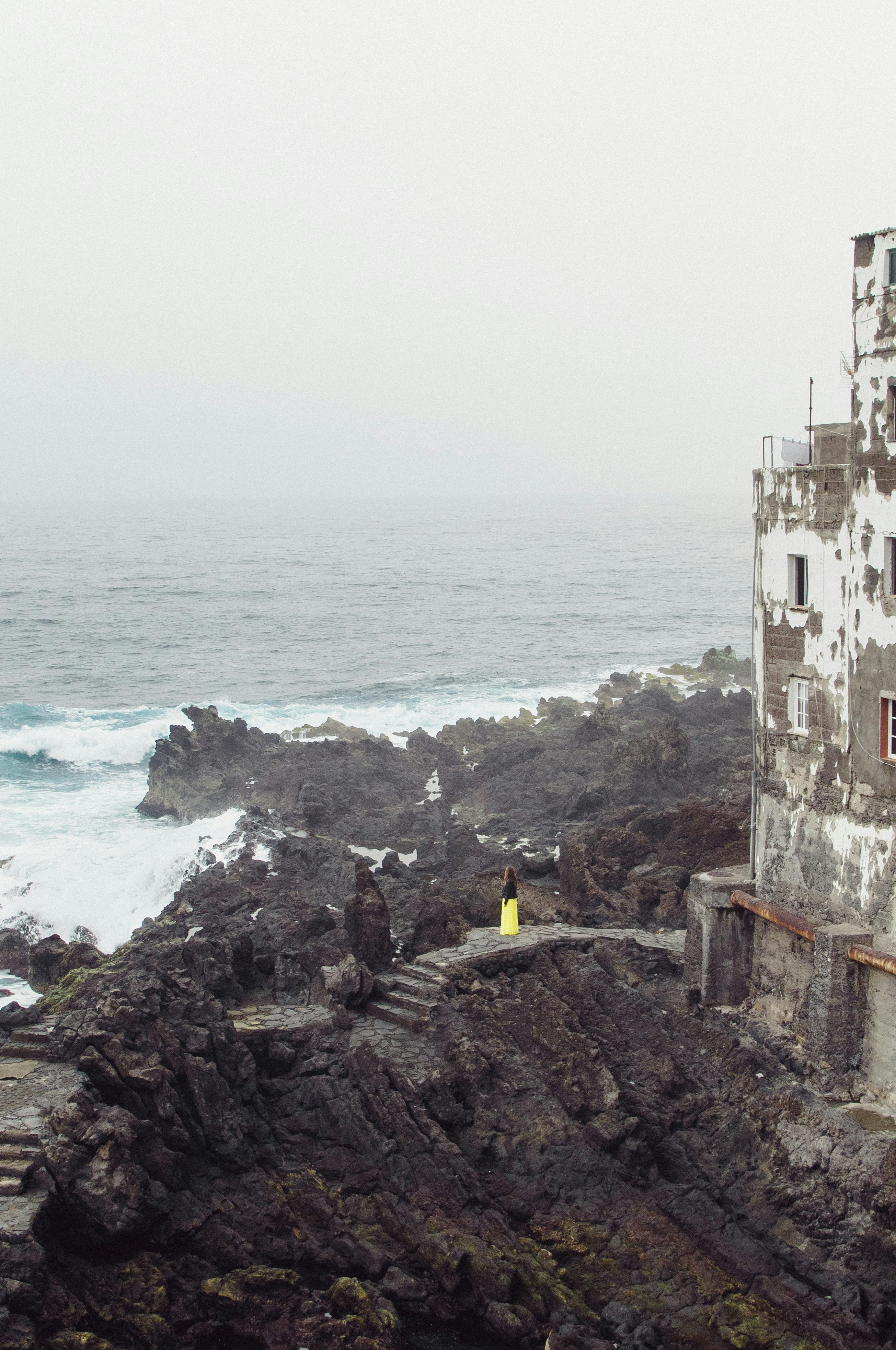 Damaged Building near Rocks on Sea Shore · Free Stock Photo