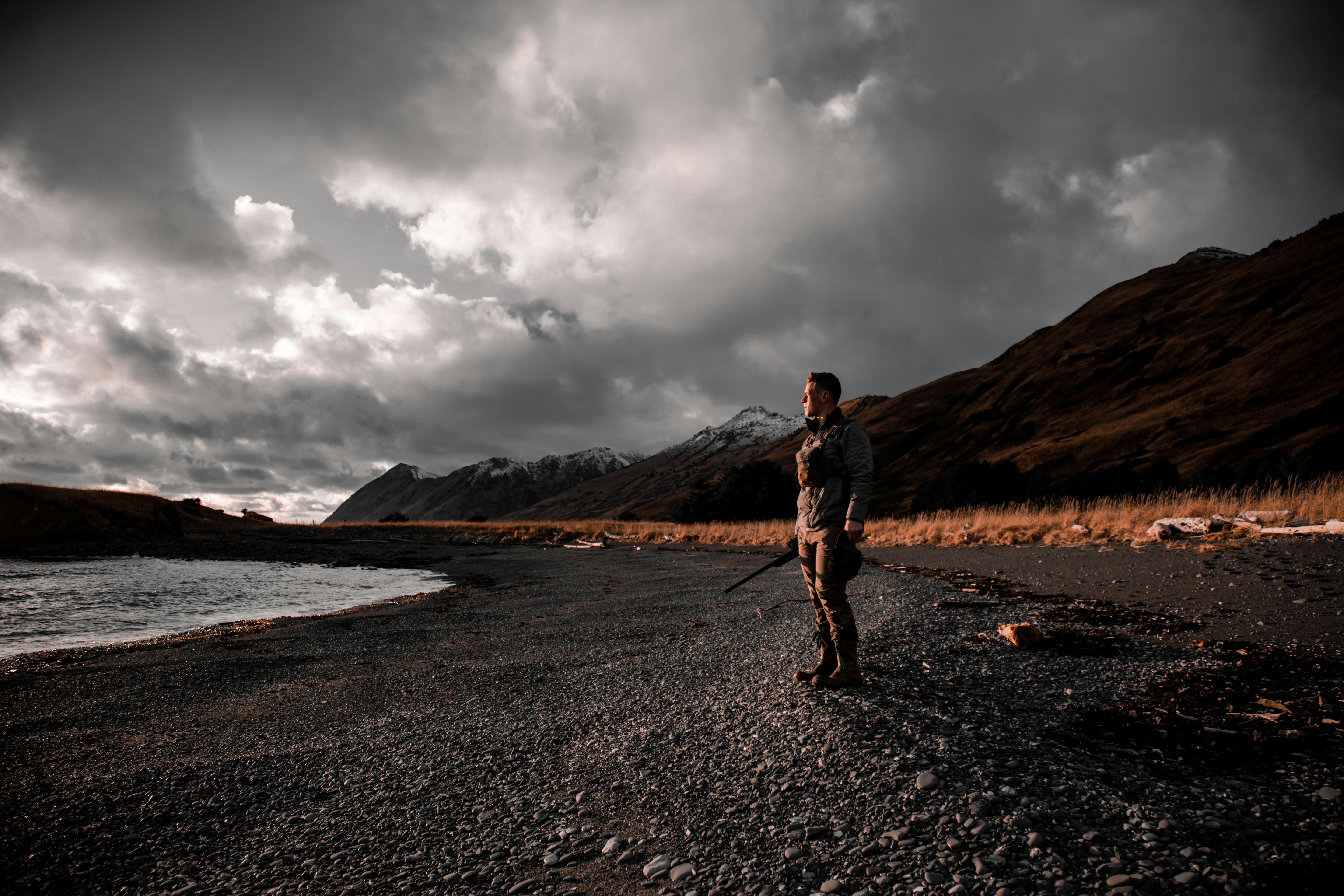 Hunter Standing near Lake · Free Stock Photo