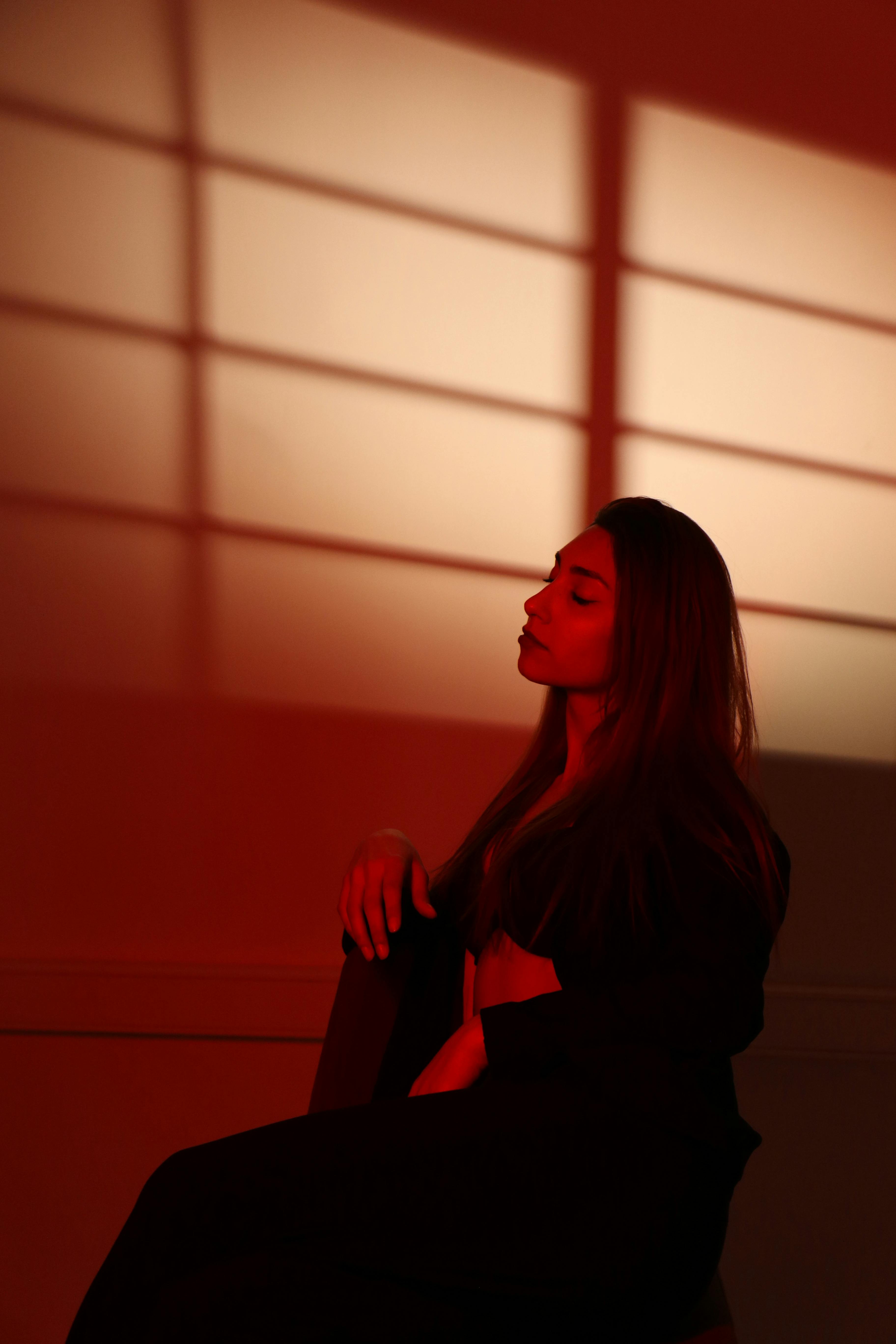 Woman in Black Cloathing in Red Lighting · Free Stock Photo