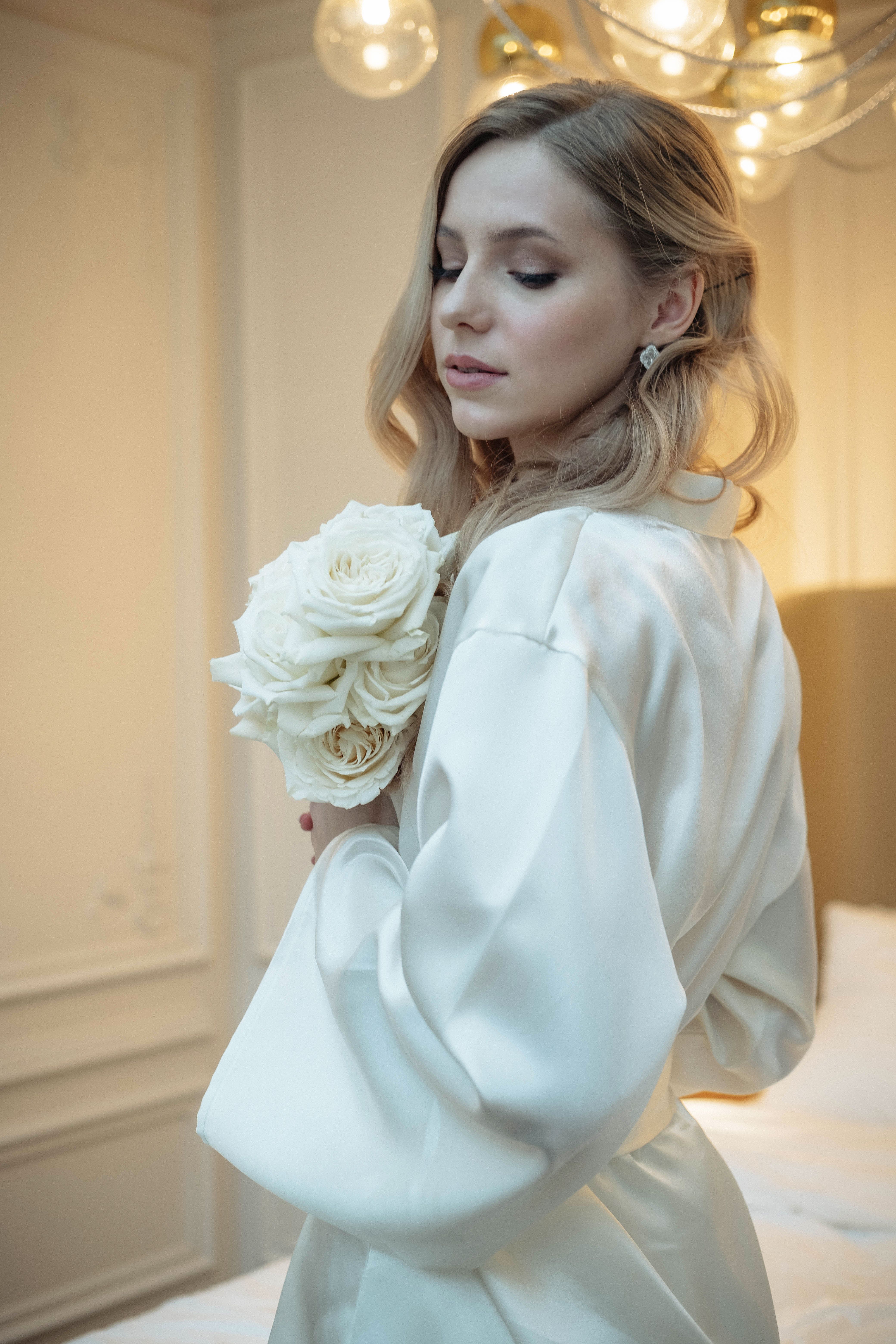 Beautiful Woman in White Clothes Holding White Flowers · Free Stock Photo