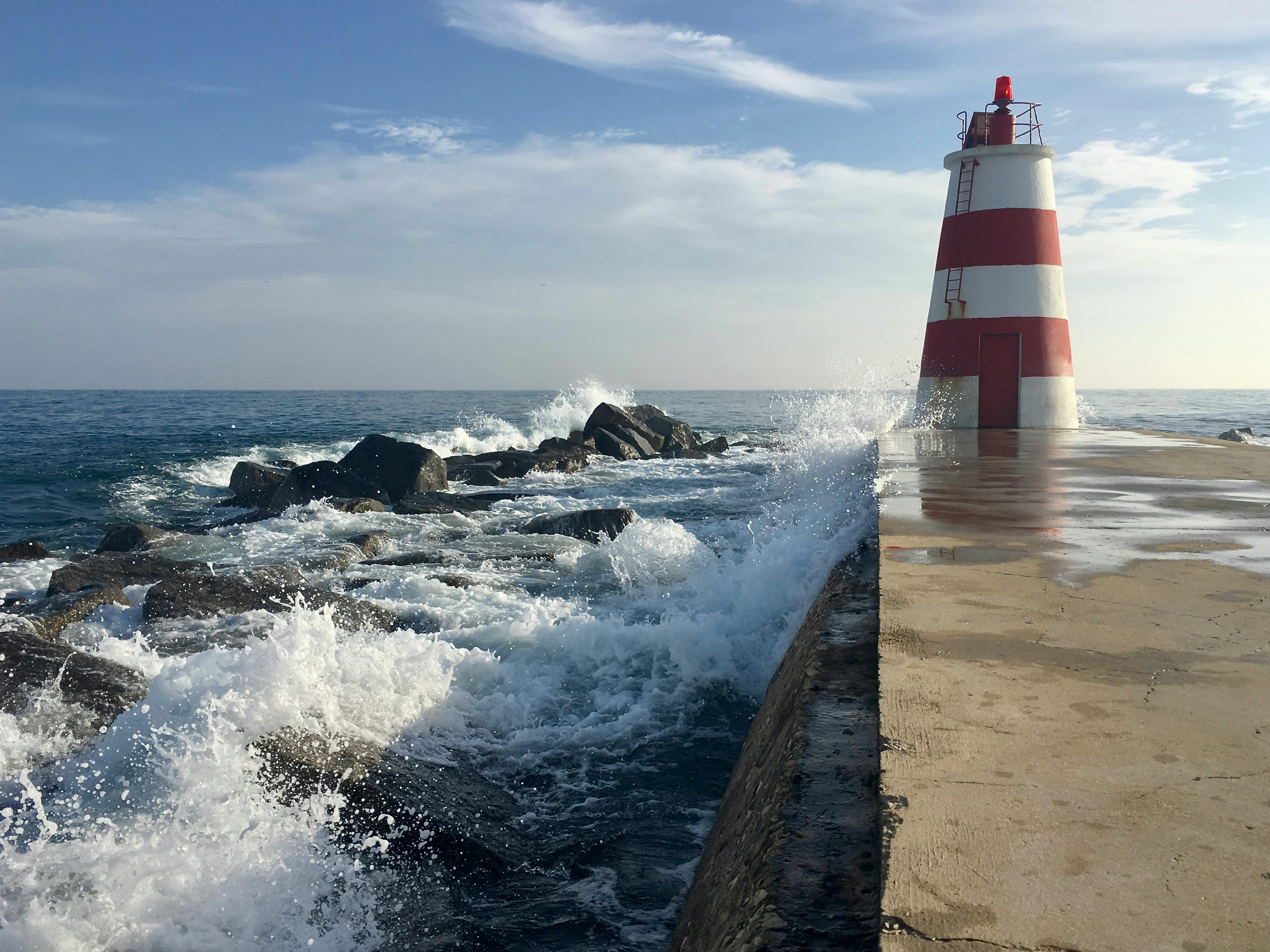 Red and White Lighthouse on Land · Free Stock Photo