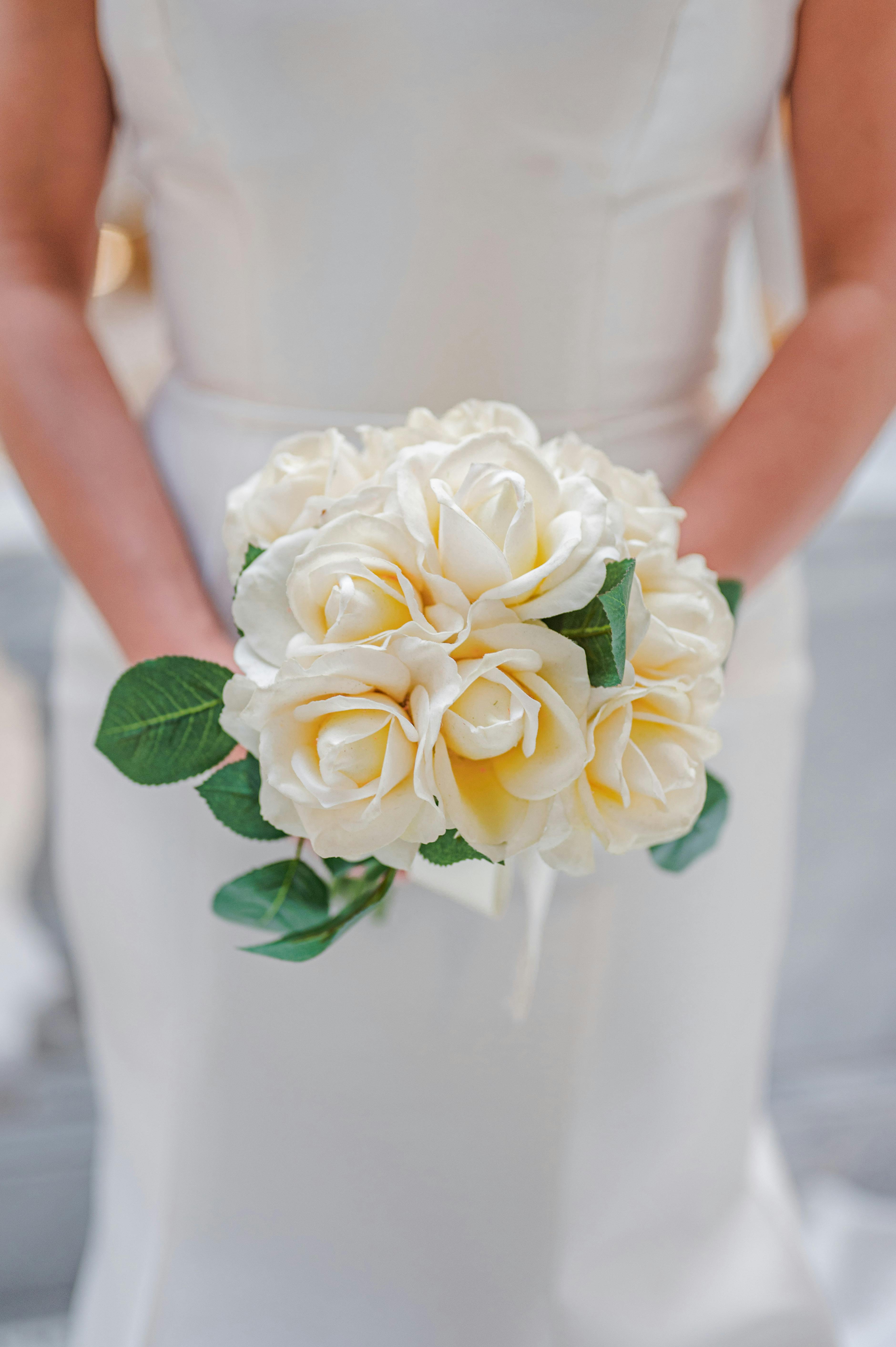 Close-up View of Bride Holding Flower Bouquet · Free Stock Photo