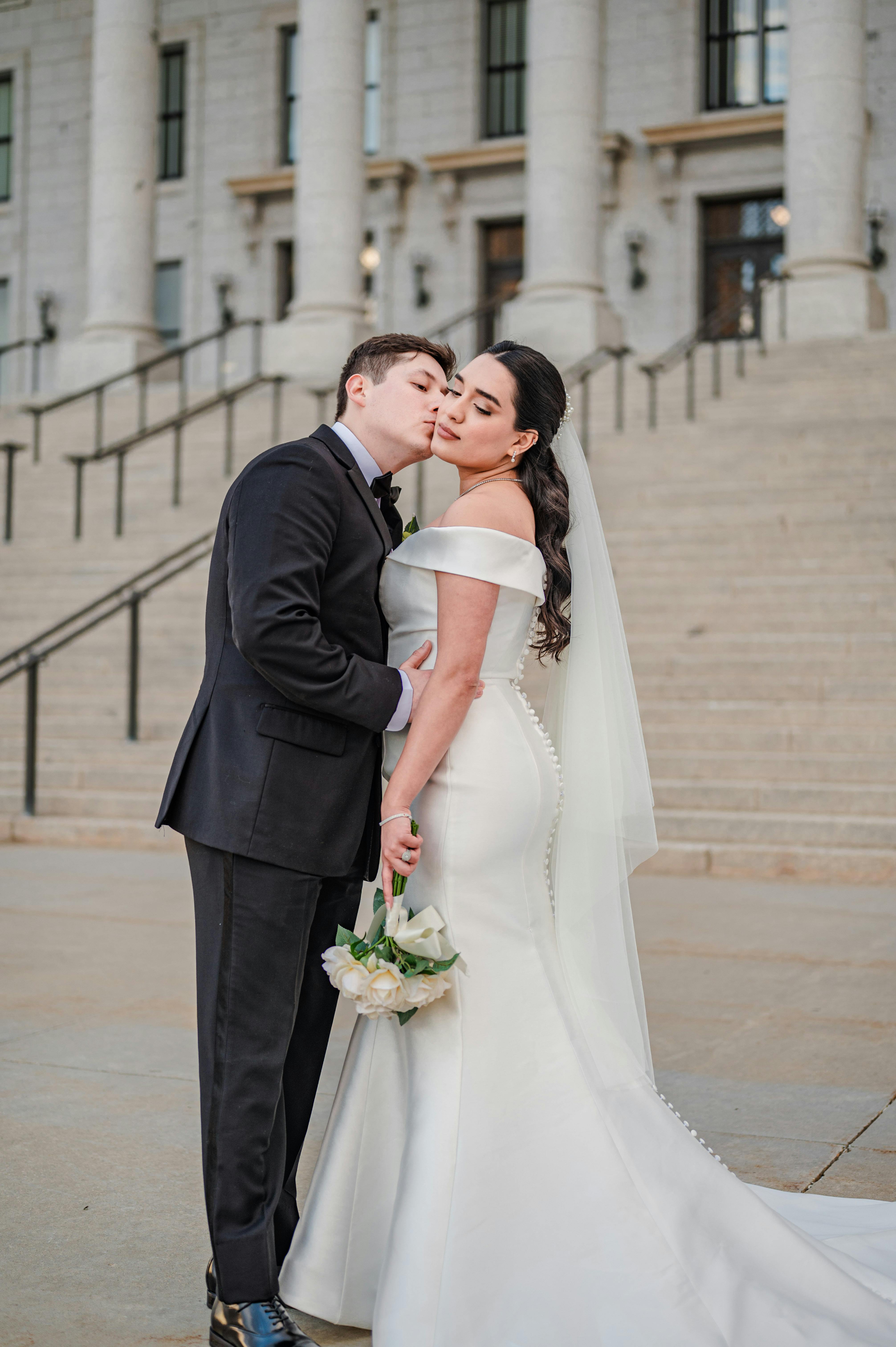 A Groom and His Bride Standing on The Grass · Free Stock Photo