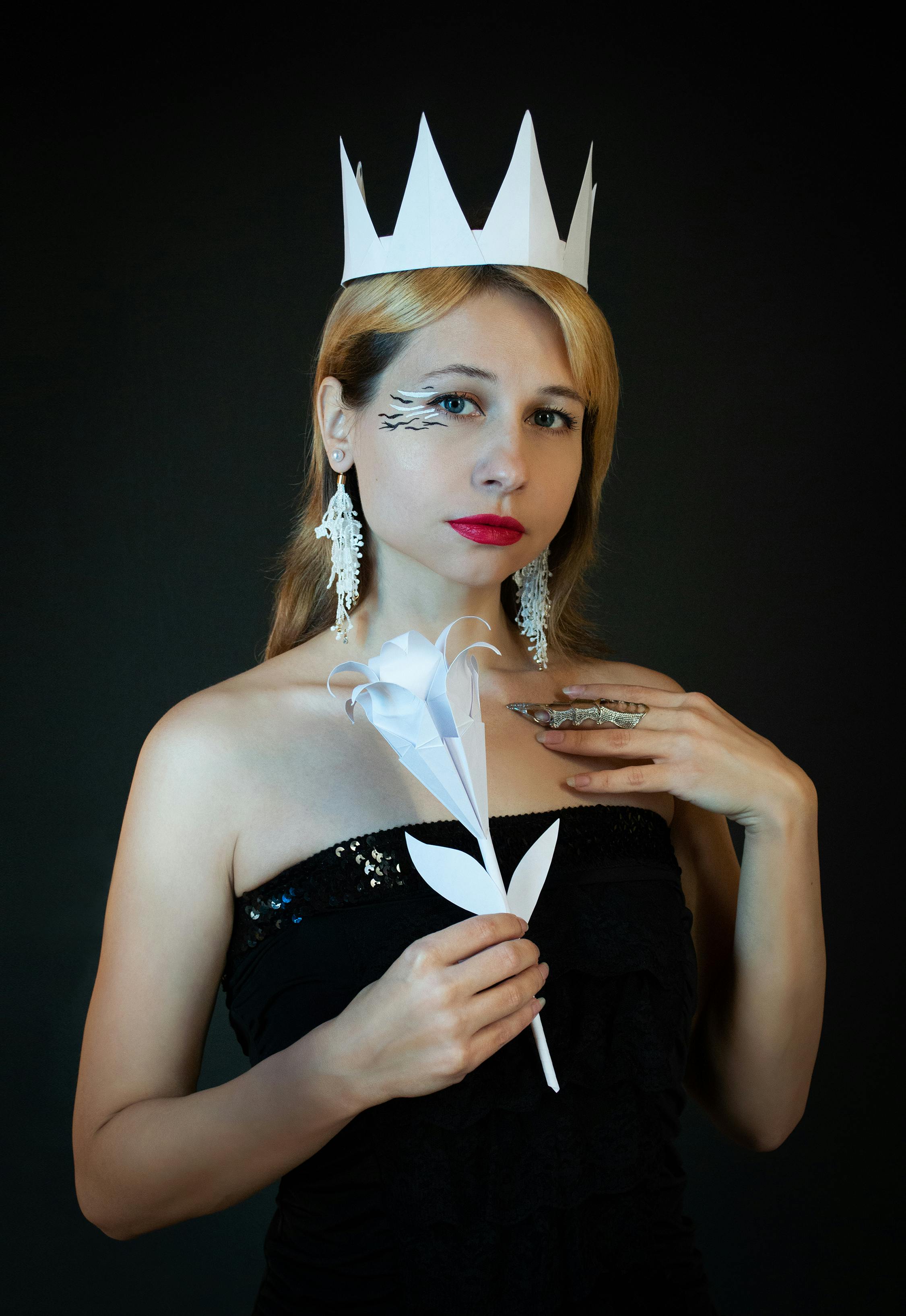 Woman Wearing Paper Crown Seriously Looking at the Camera while Holding ...