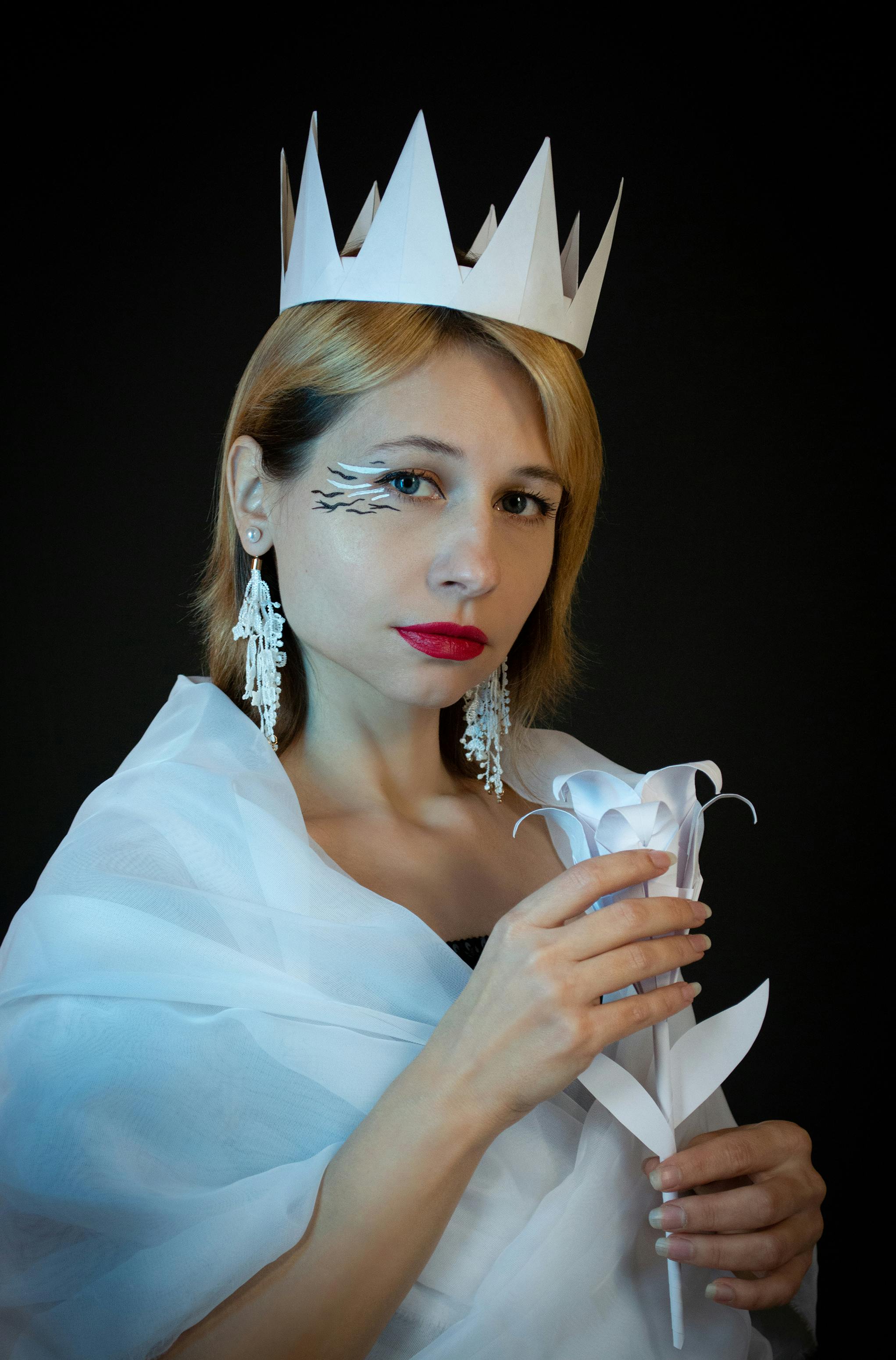 Woman Wearing Paper Crown Seriously Looking at the Camera while Holding ...
