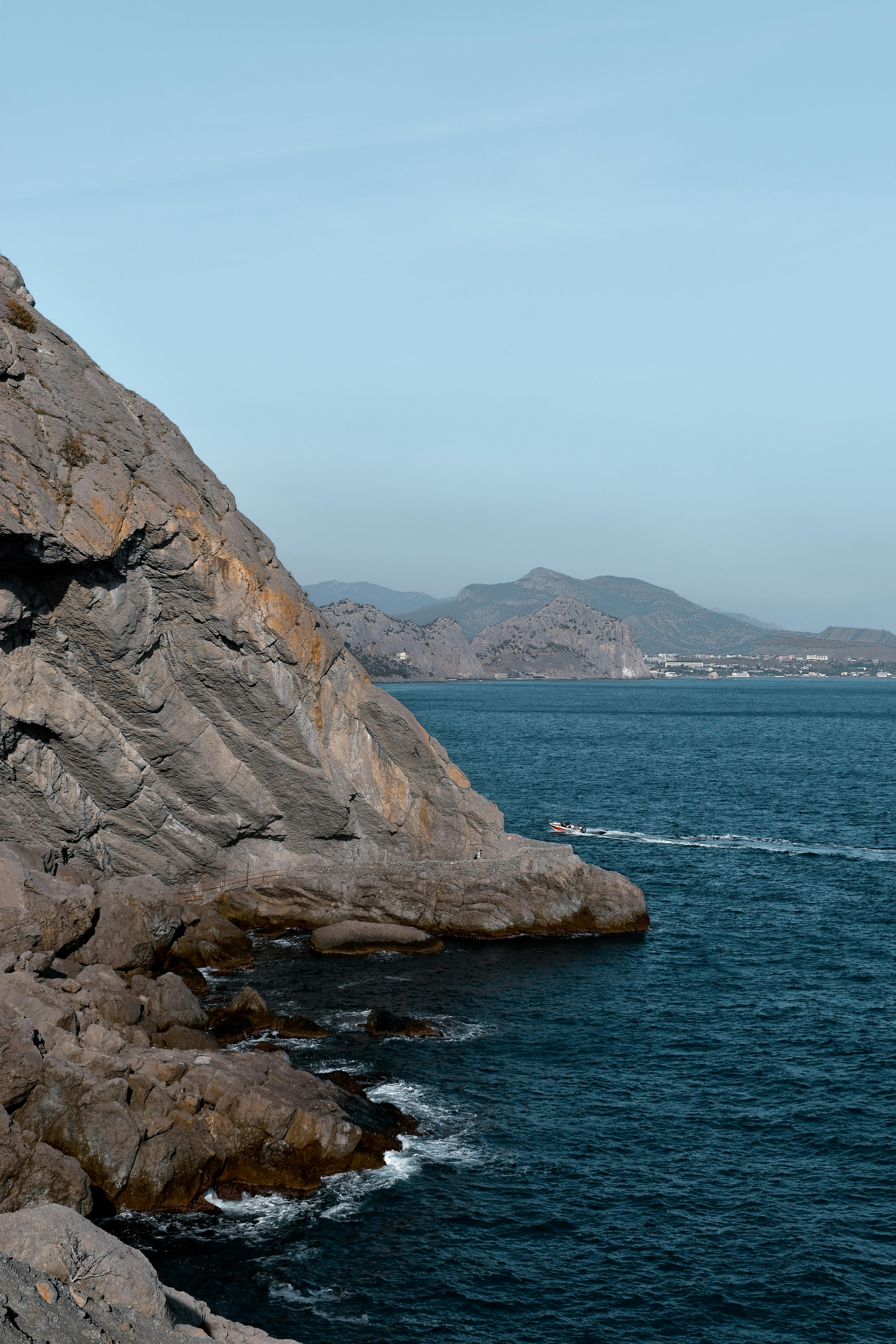 Body of Water Near Cliff · Free Stock Photo