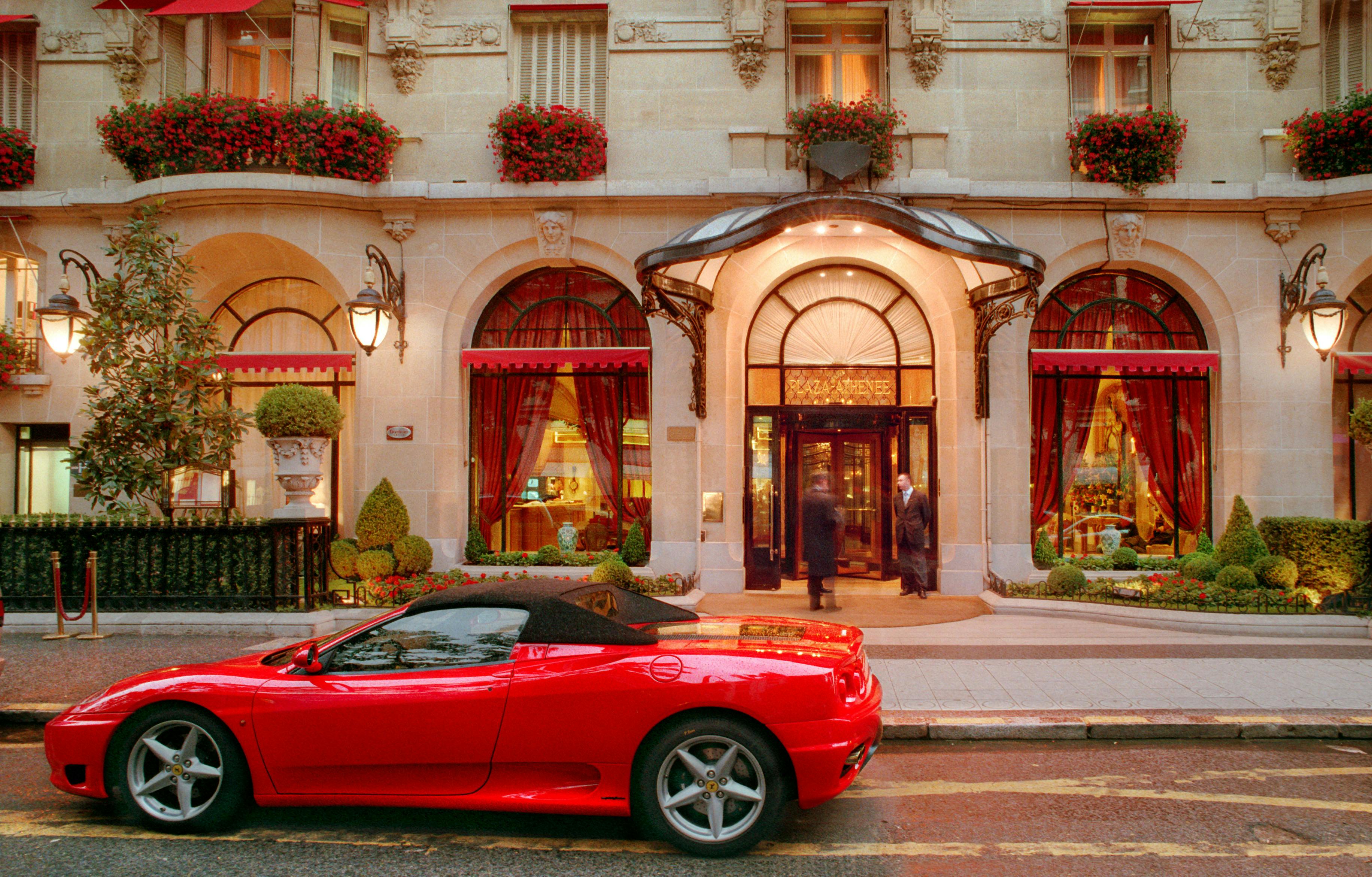 A Red Ferrari Car Parked on the Street in Front of the Hotel · Free ...