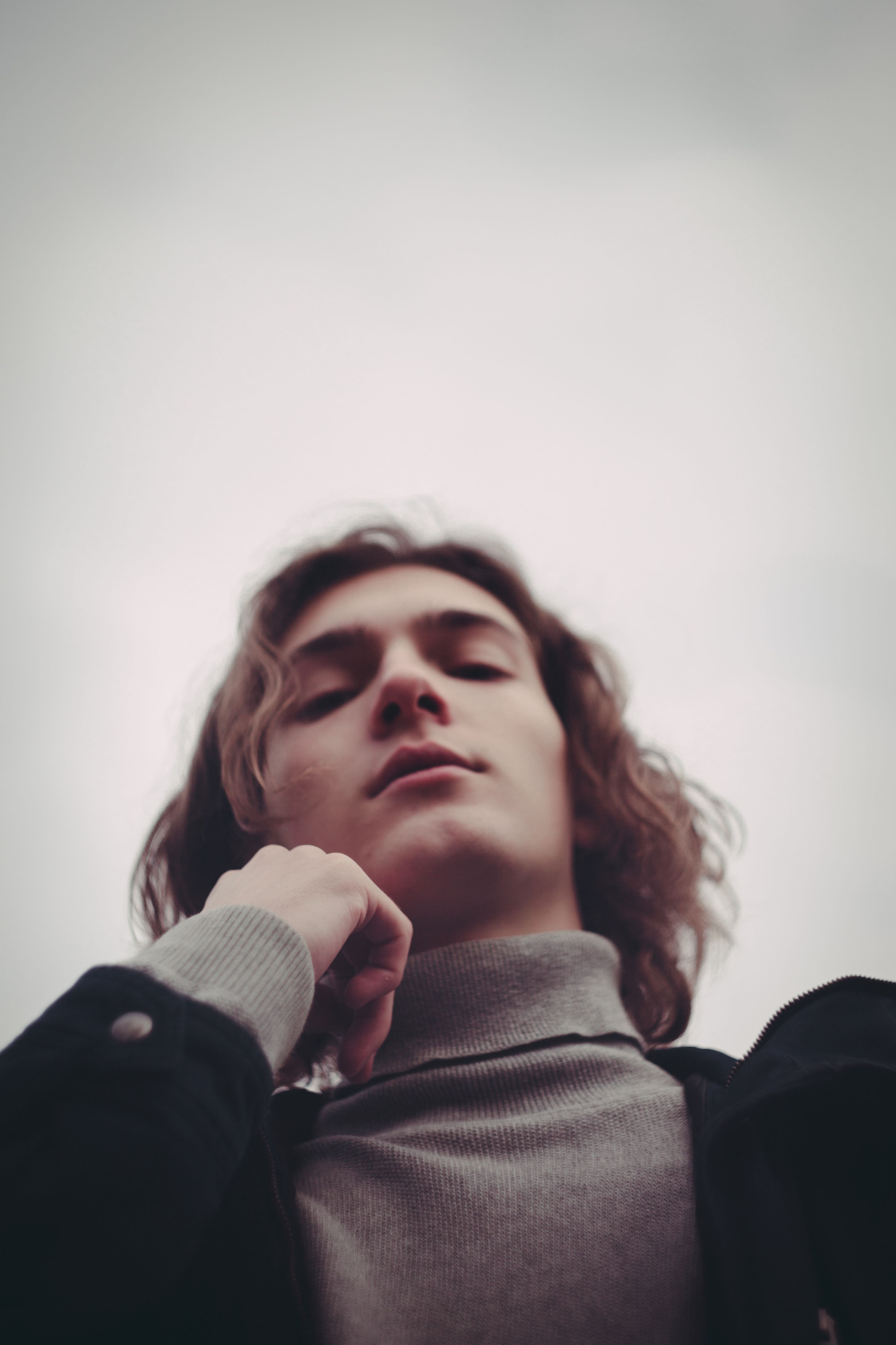 Low-Angle Shot of a Man Under a Building · Free Stock Photo