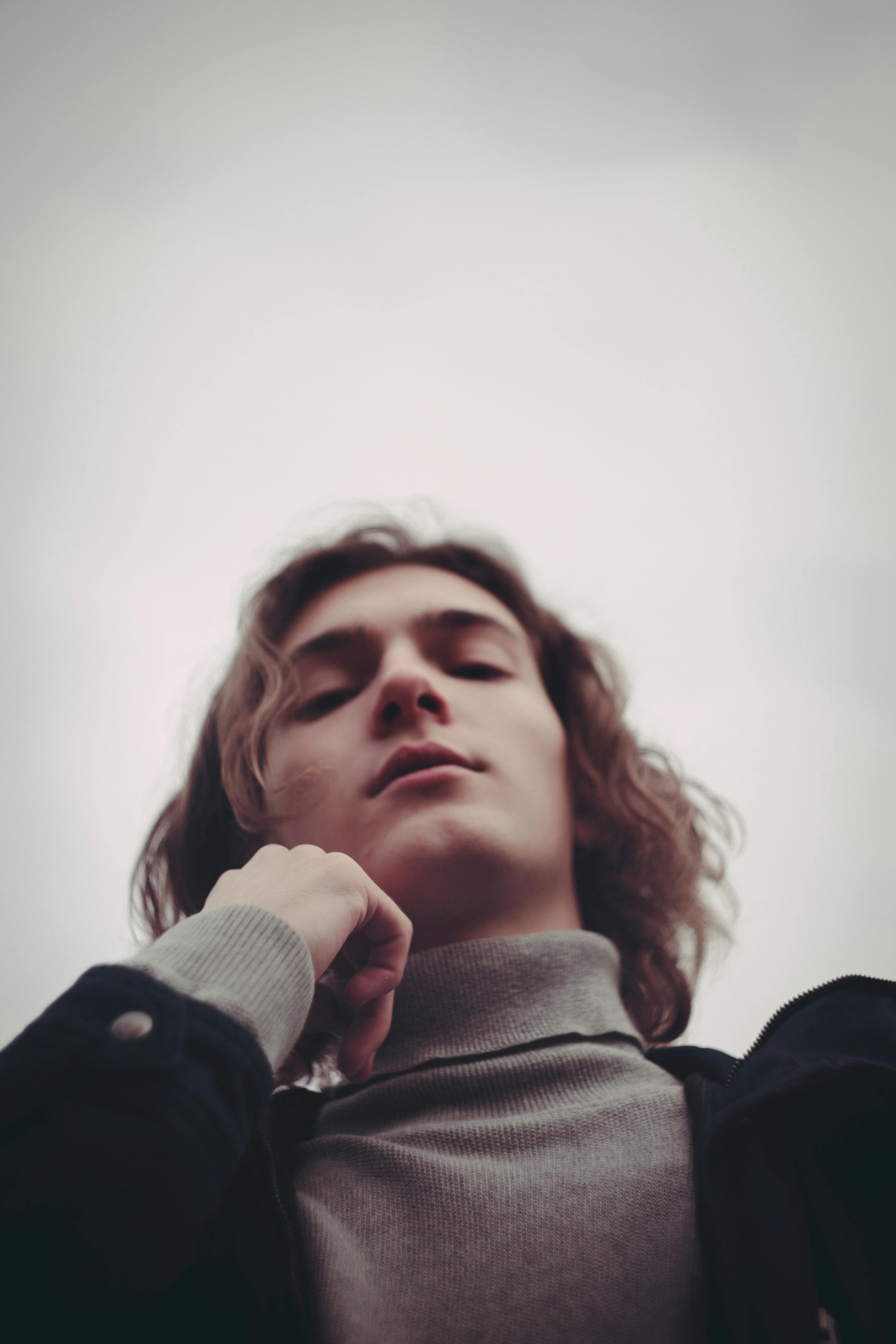 Low-Angle Shot of a Man Under a Building · Free Stock Photo