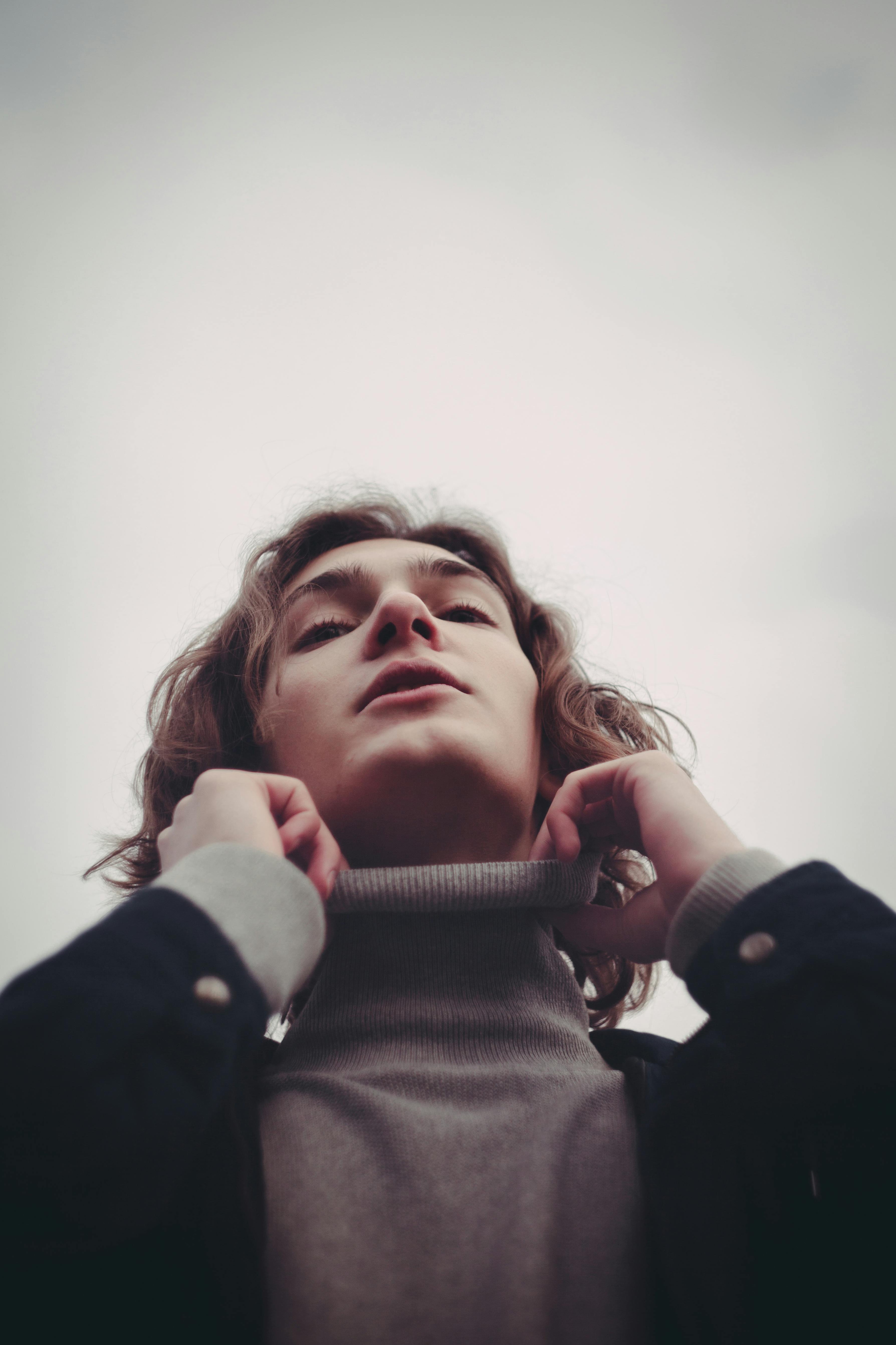 Low-Angle Shot of a Man Under a Building · Free Stock Photo