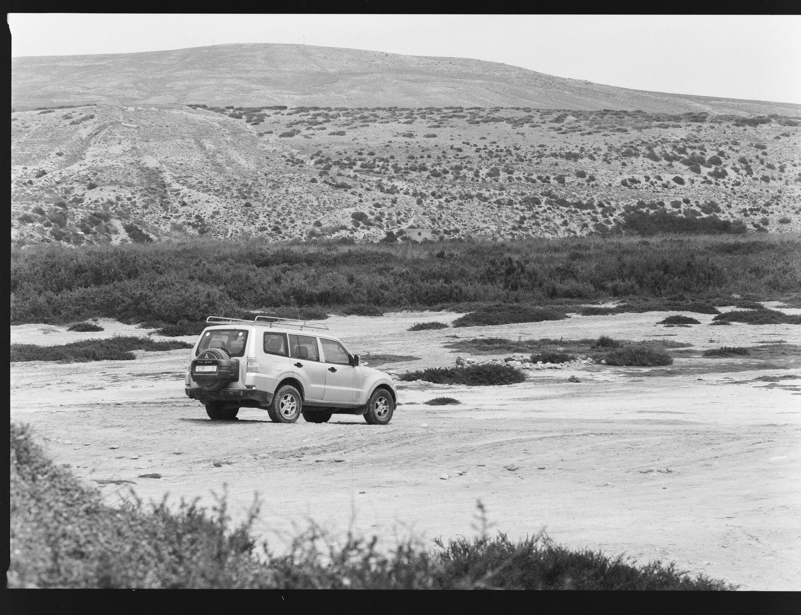 Grayscale Photo of a Car Driving Off-road · Free Stock Photo
